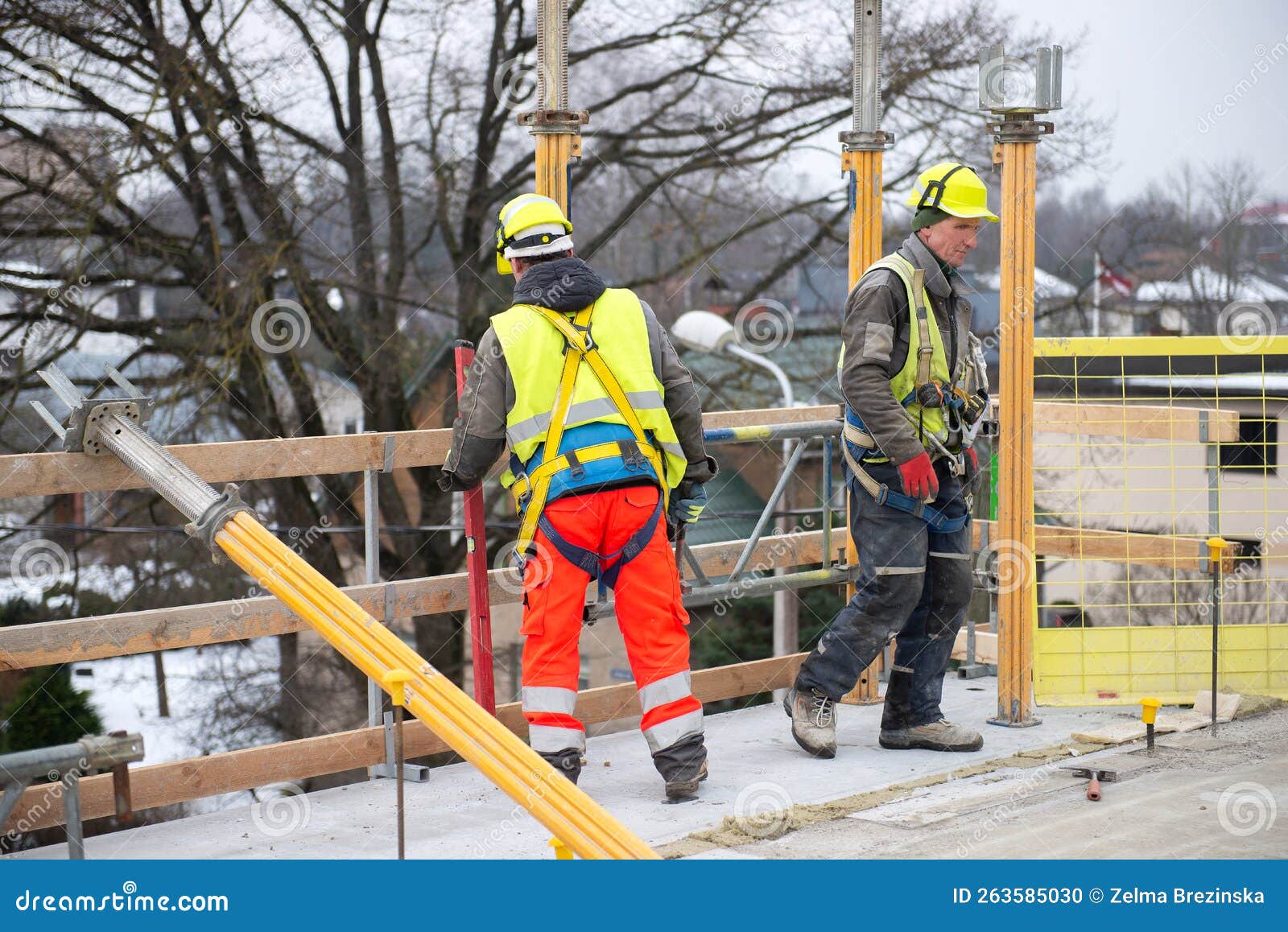 Two Builder Construction Workers in the Work Process on Building Site ...