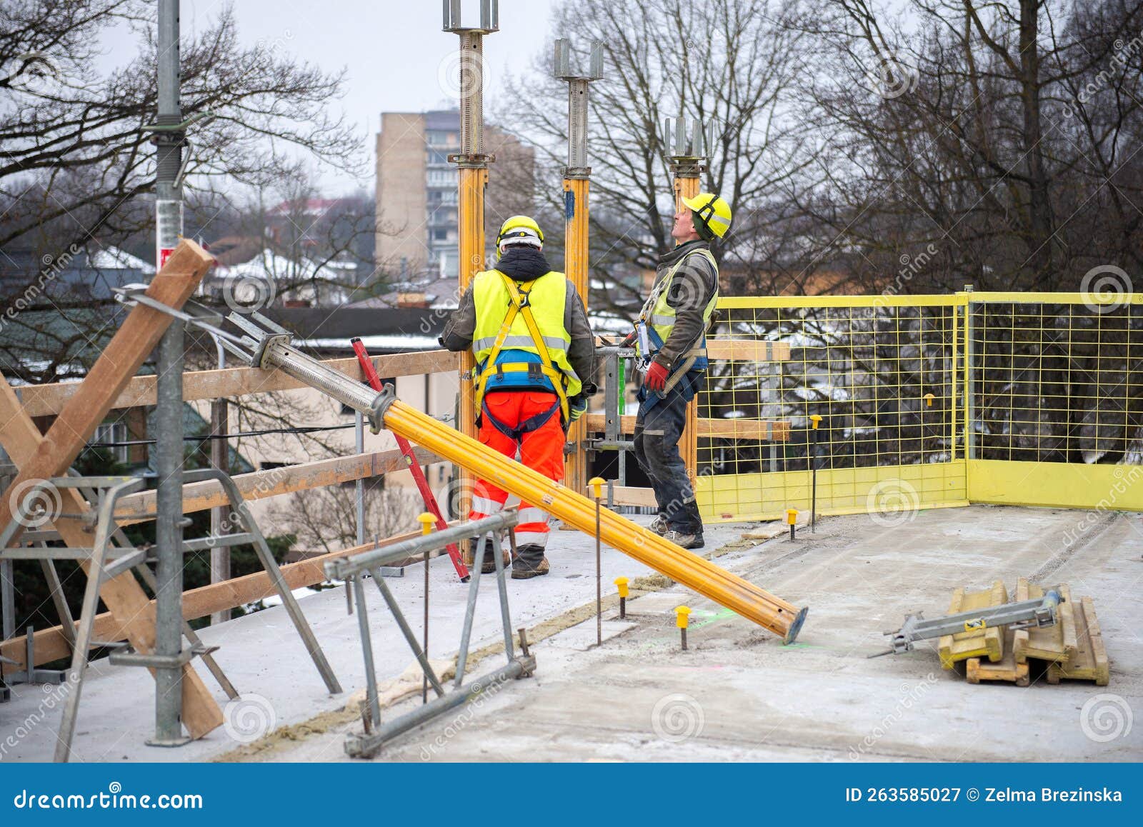 Two Builder Construction Workers in the Work Process on Building Site ...