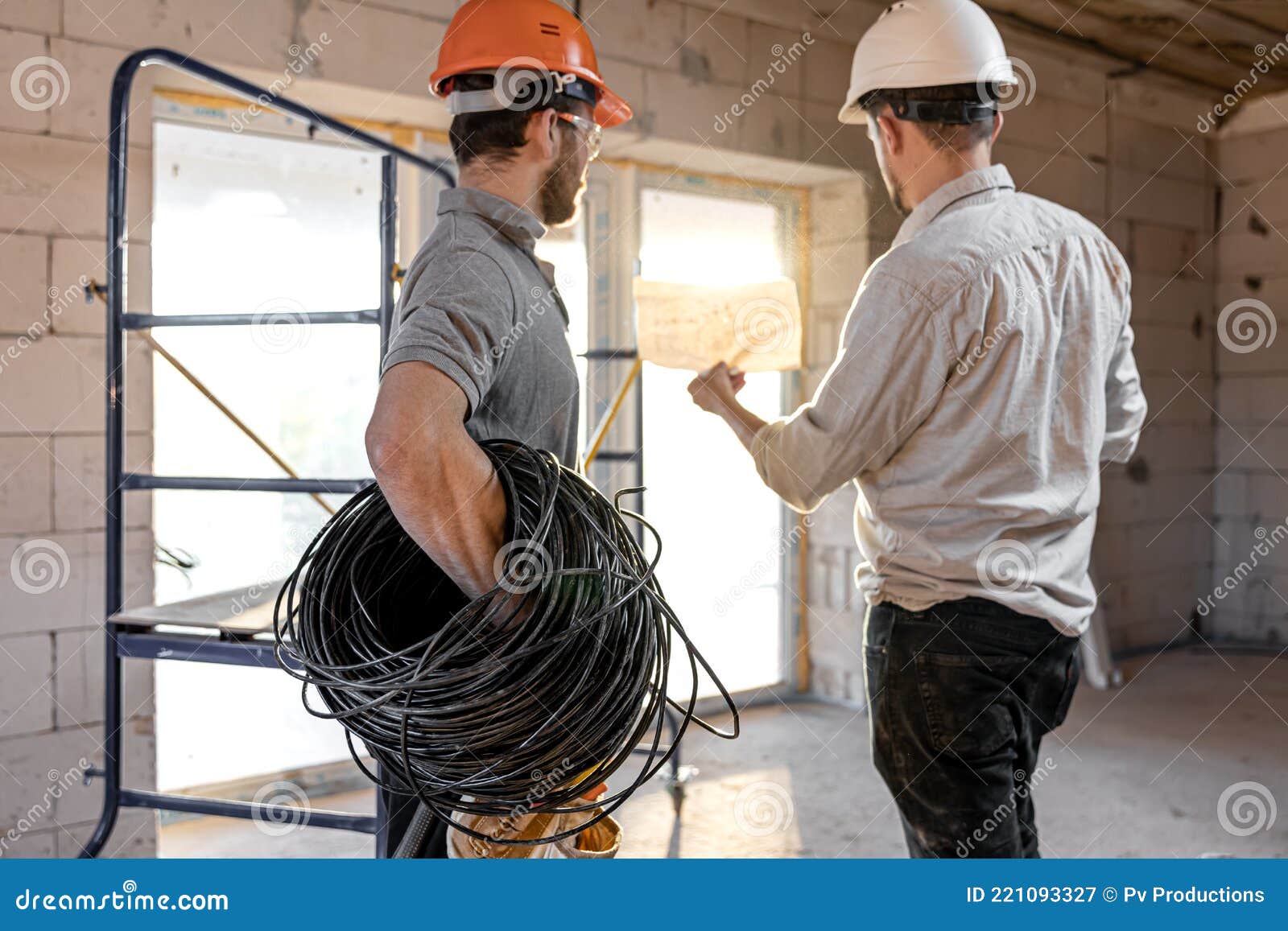 Two Builders Look at the Drawing of the Object Stock Image - Image of ...