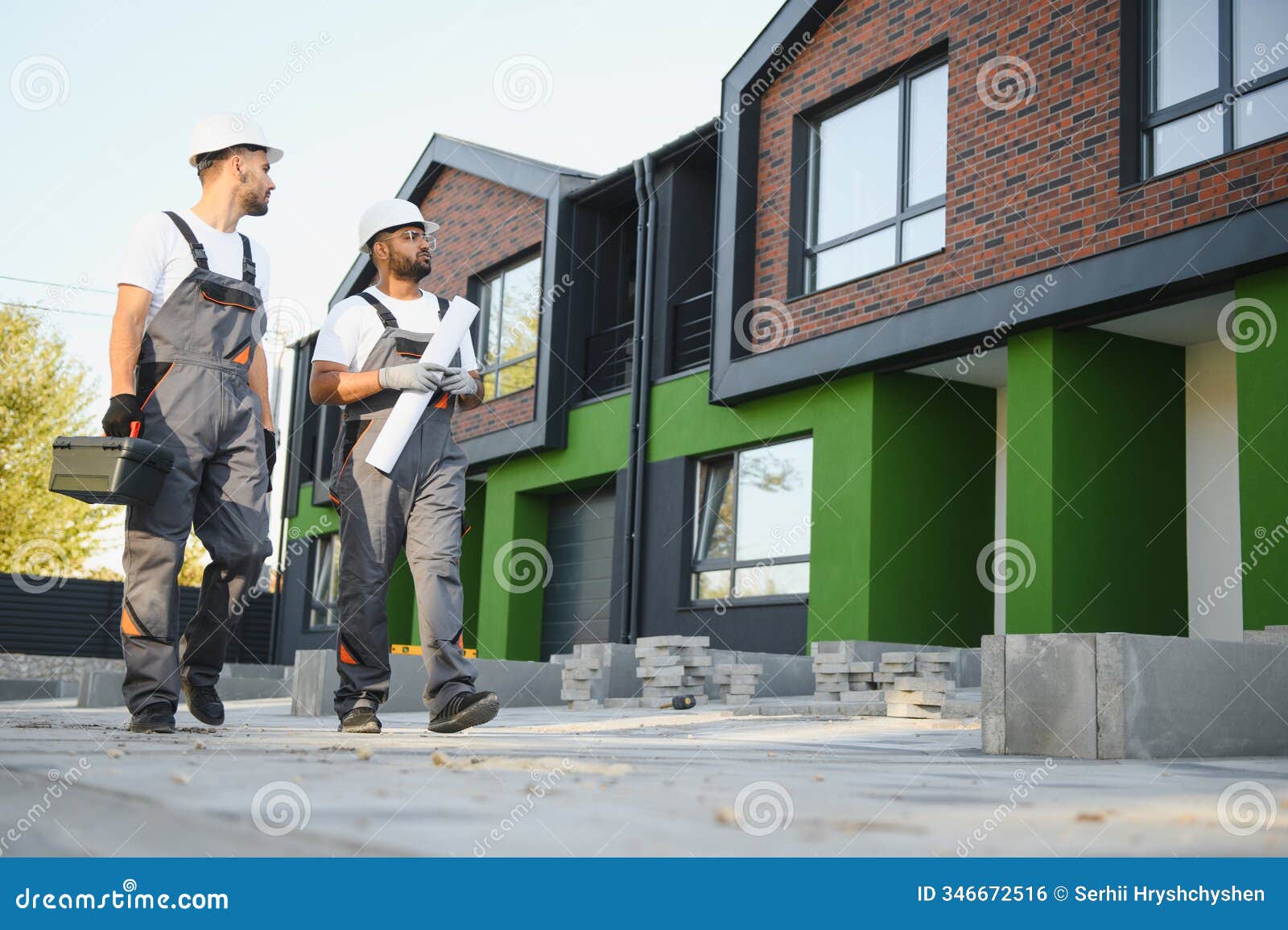 Two Builders on the Background of New Cottages. the Work is Done Stock ...