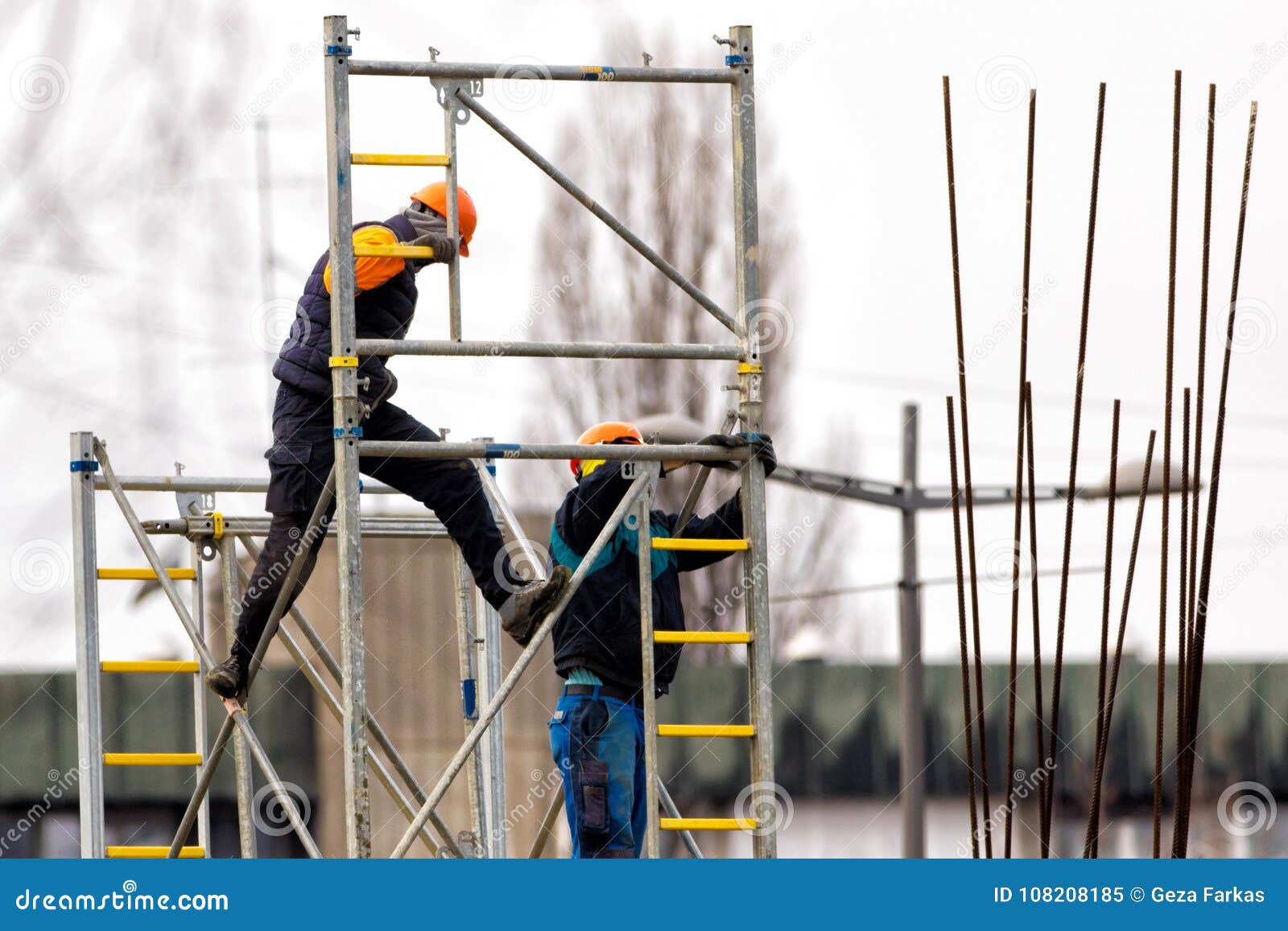 Two Workers Build Metal Scaffolding on Construction Site Stock Image ...