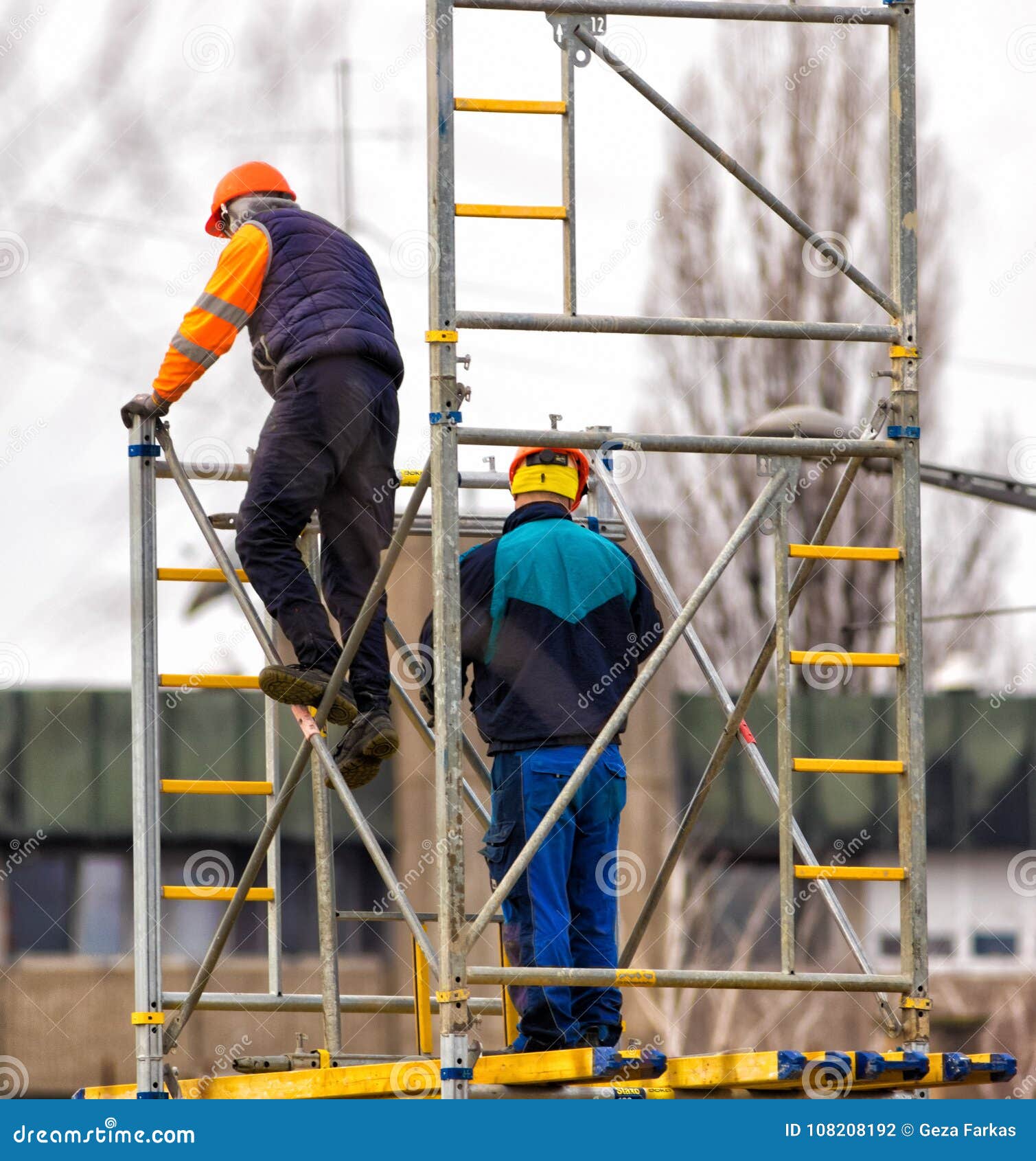 Two Builders Build Metal Scaffolding on Construction Site Stock Photo ...