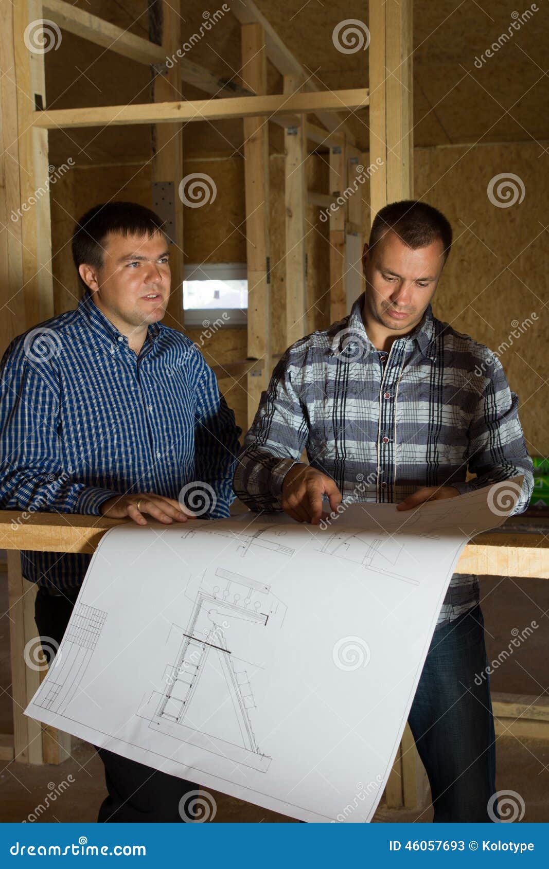Two Builders Checking a Blueprint Together Stock Image - Image of ...