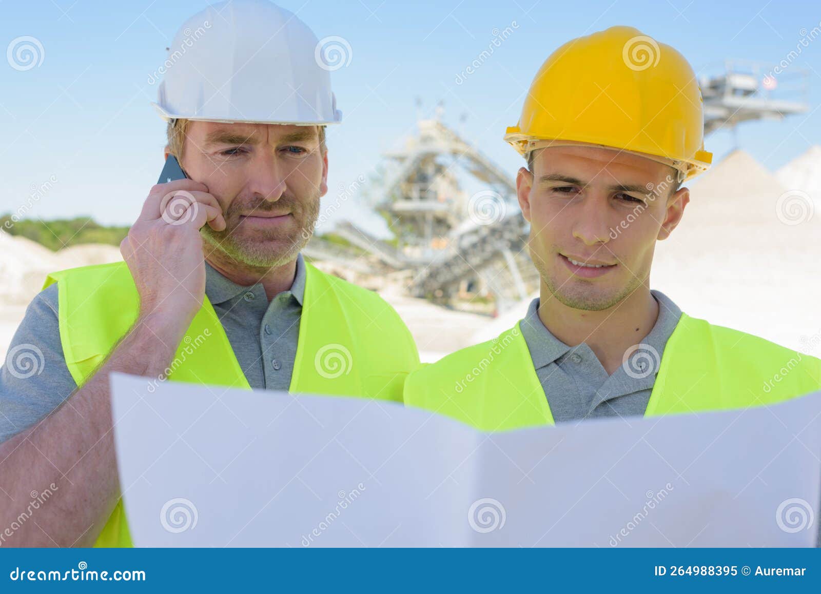 Two Builders on Construction Site Looking at Plans Stock Image - Image ...
