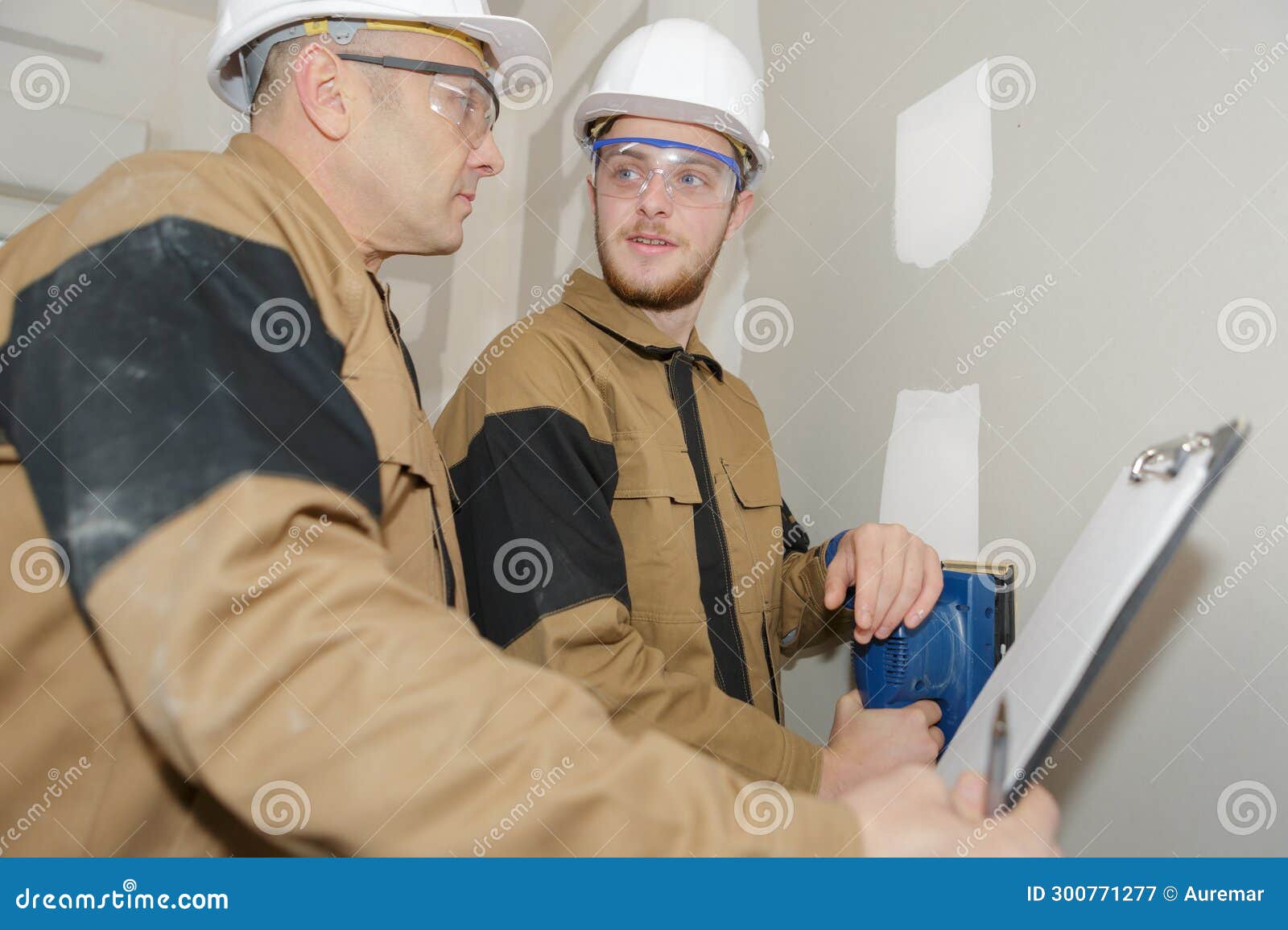 Two Builders in Helmets Working with Electricity Indoors Stock Image ...