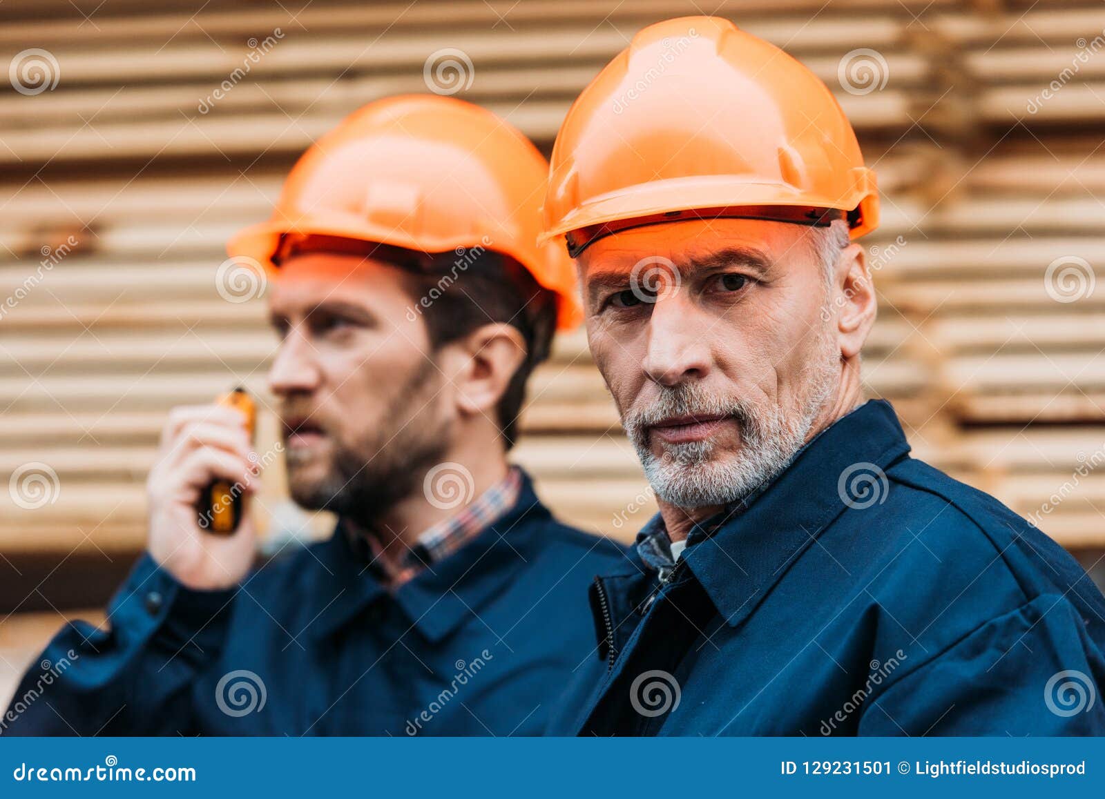 Two Builders in Helmets Working Outside Stock Image - Image of teamwork ...