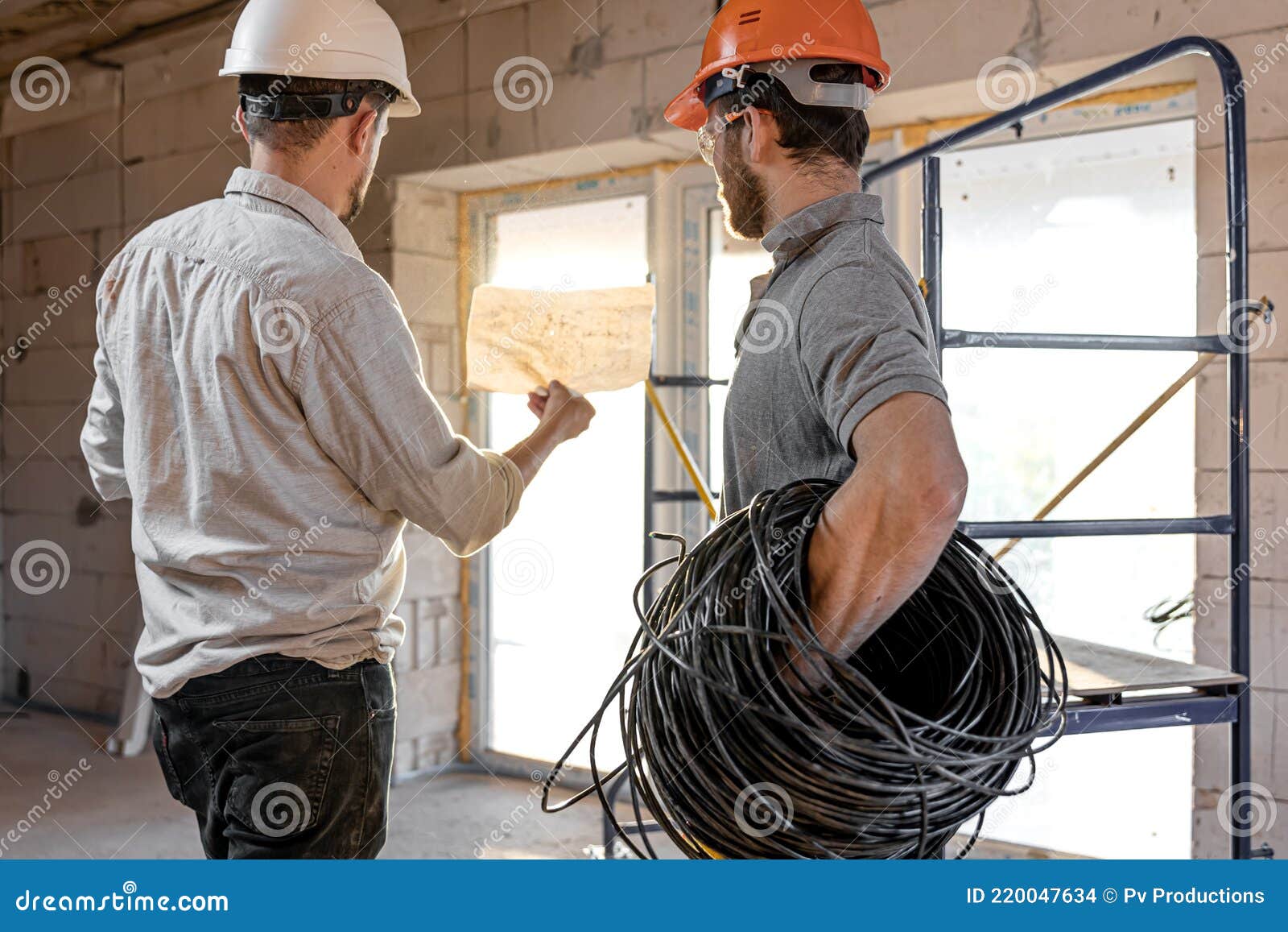Two Builders Look at the Drawing of the Object Stock Photo - Image of ...