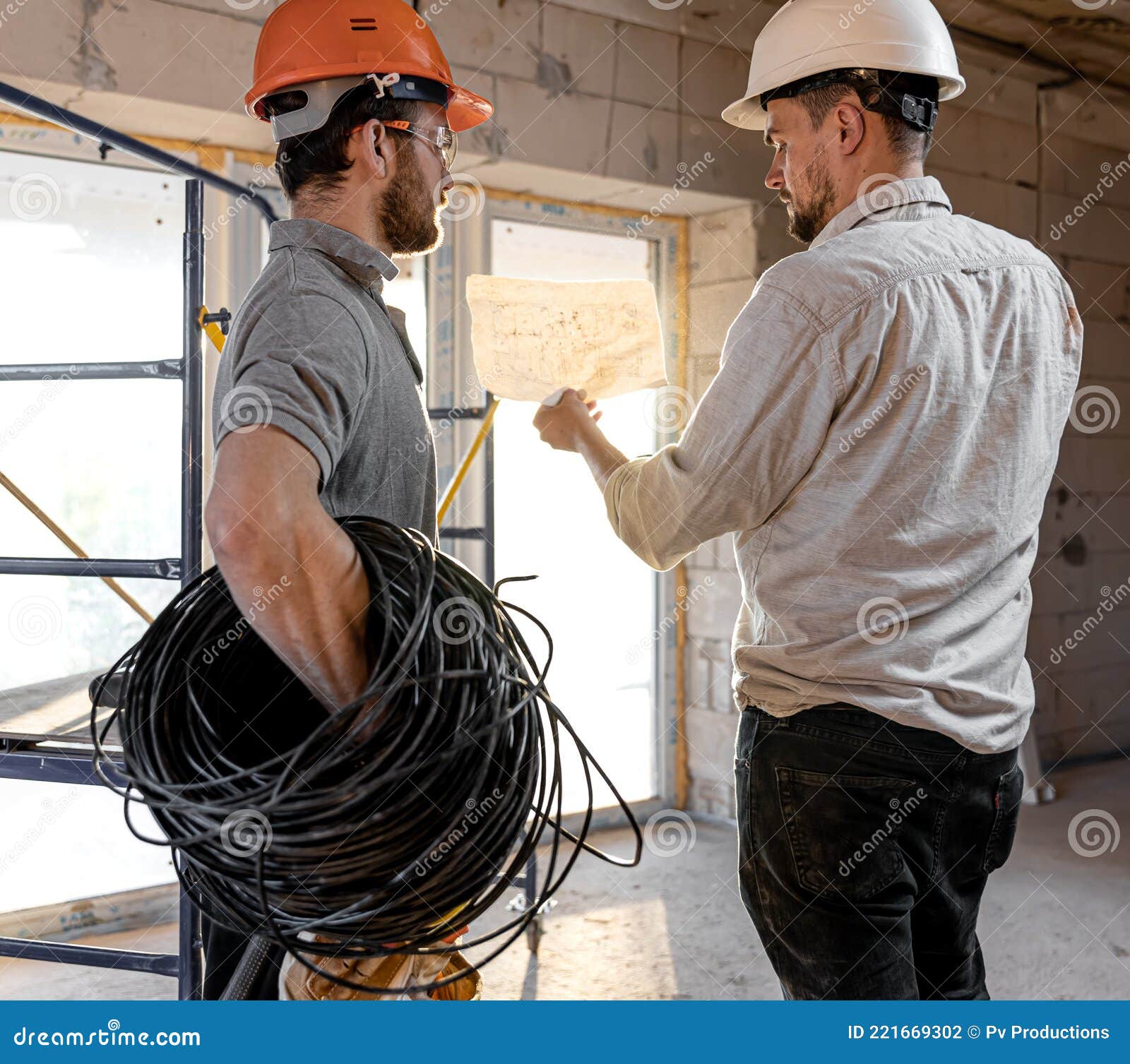 Two Builders Look at the Drawing of the Object Stock Photo - Image of ...