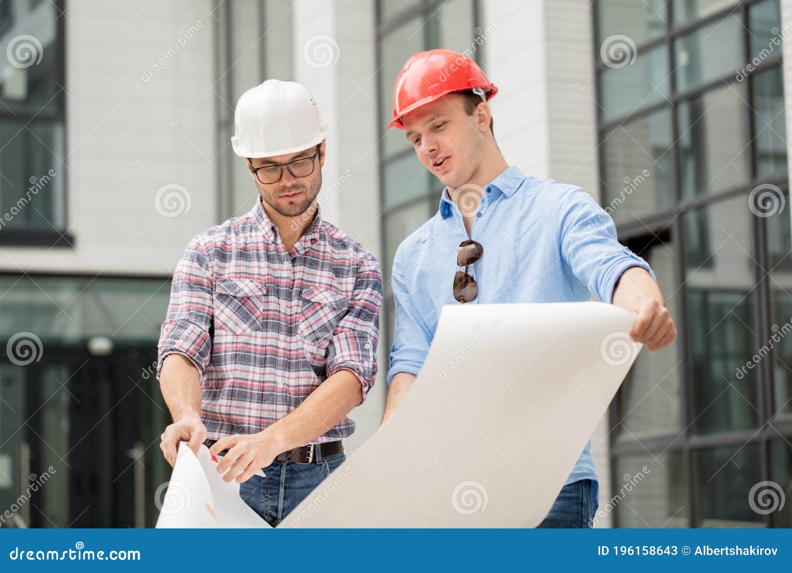 Two Builders are Looking through the Diagram Stock Image - Image of ...