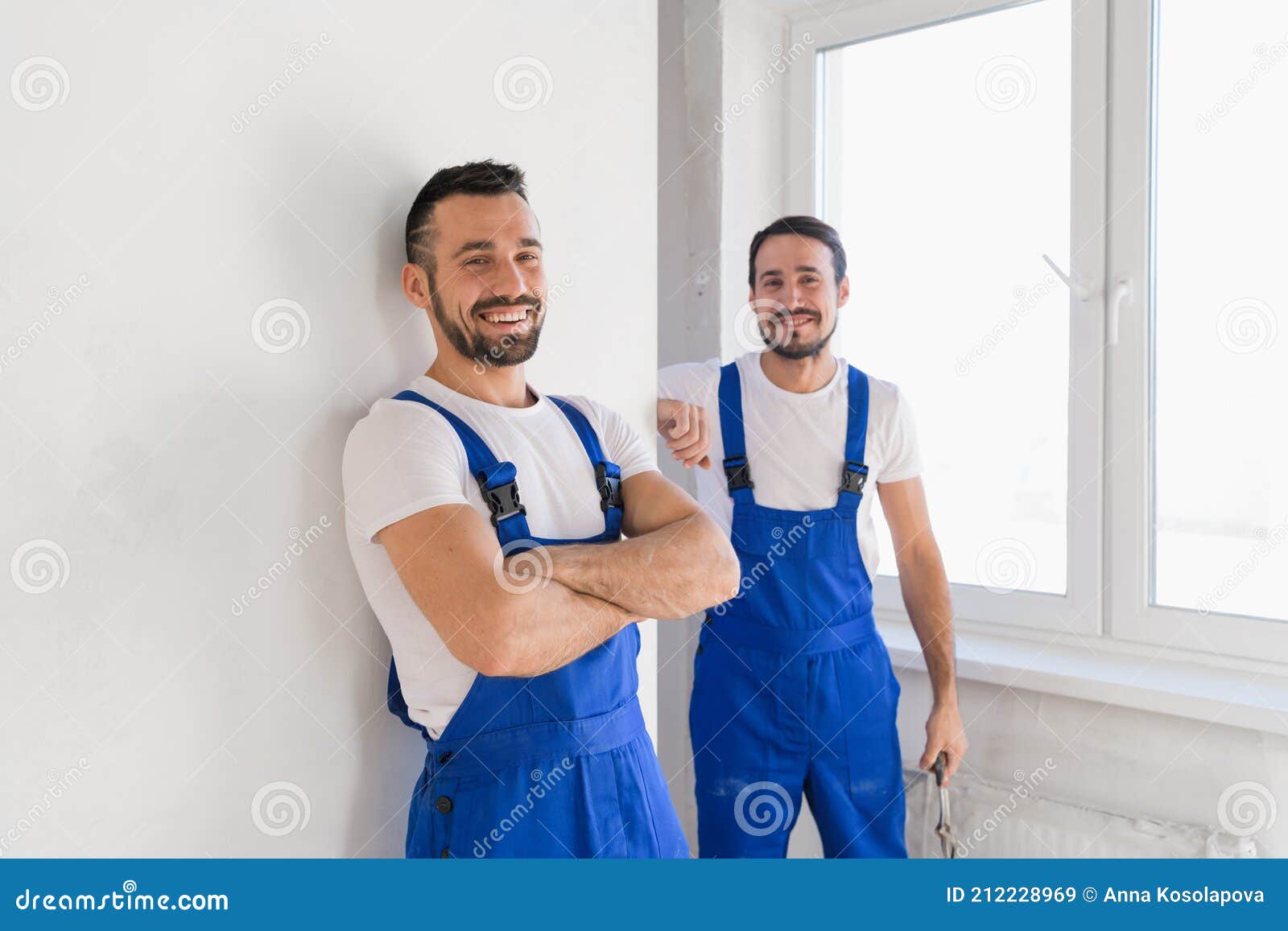 Two Builders in Overalls Look at the Camera Stock Image - Image of ...