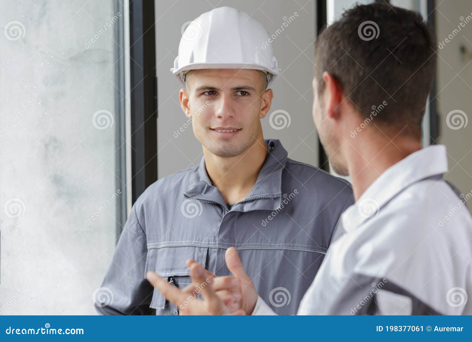 Two Builders Talking Indoors Stock Image - Image of room, professionals ...