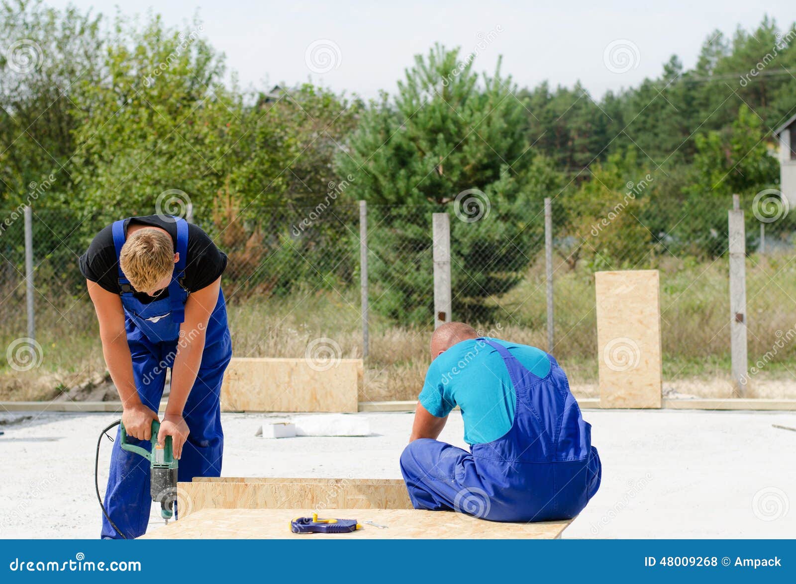Two Builders Working on a Building Site Stock Photo - Image of ...