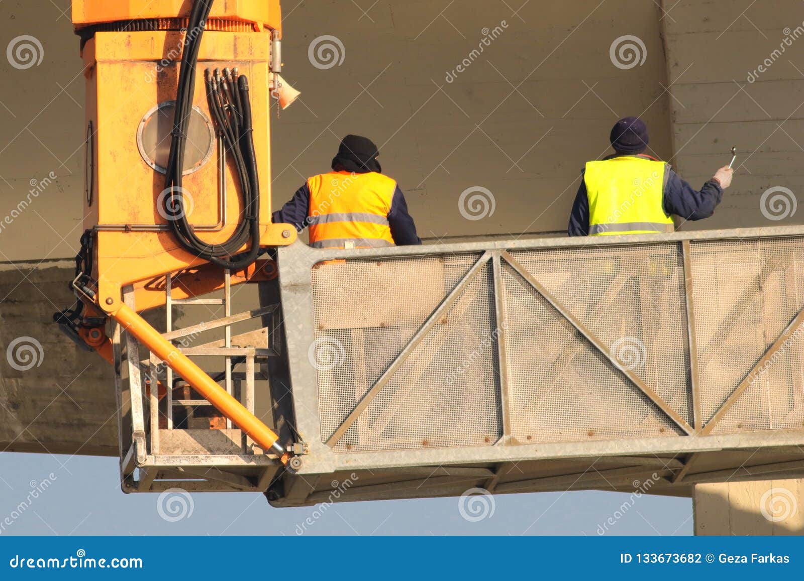 Two Builders in Yellow at the Construction Site Work on Crane Stock ...