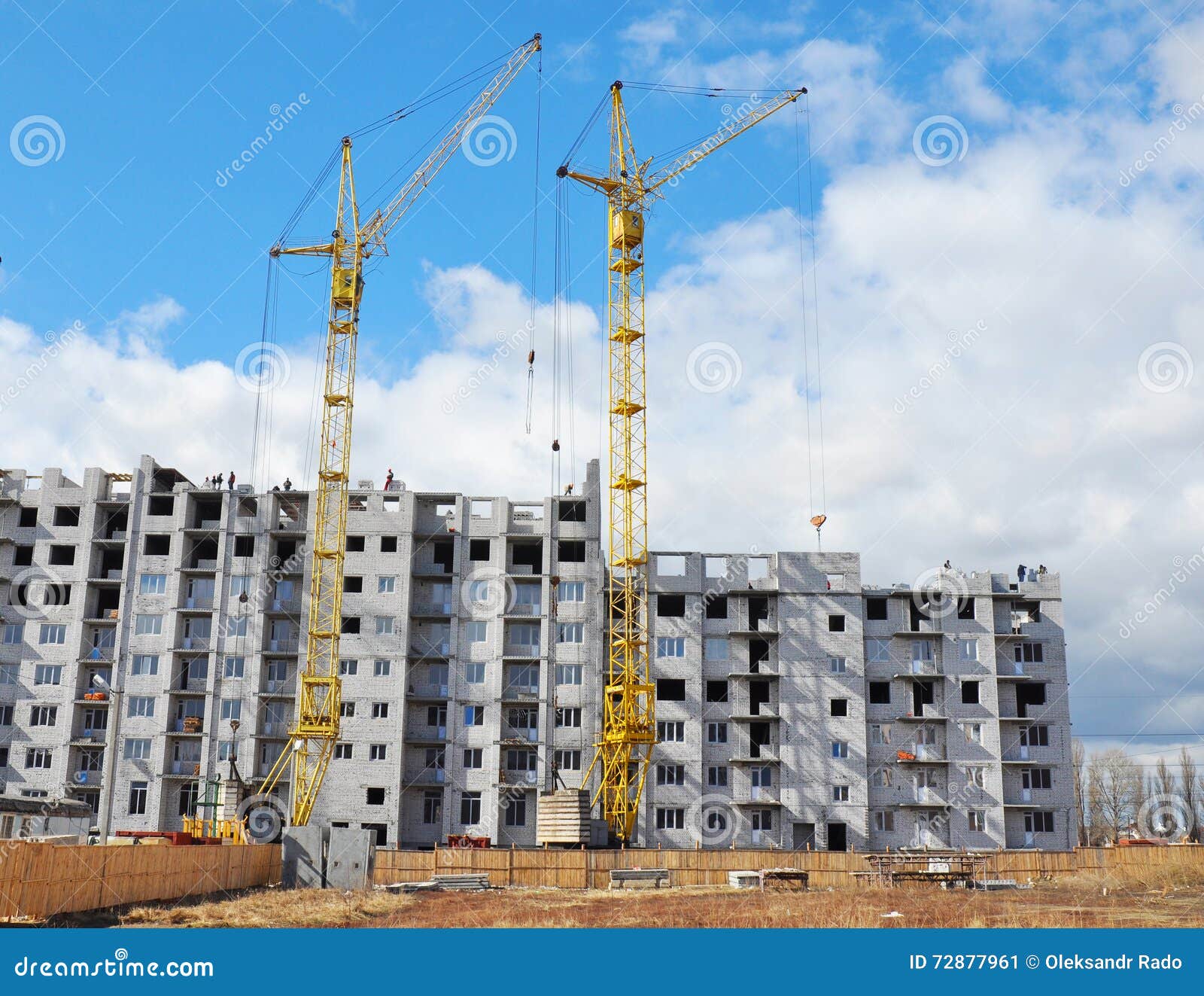 Building Cranes At Front Of A Multi-storey Uilding Under Construction ...