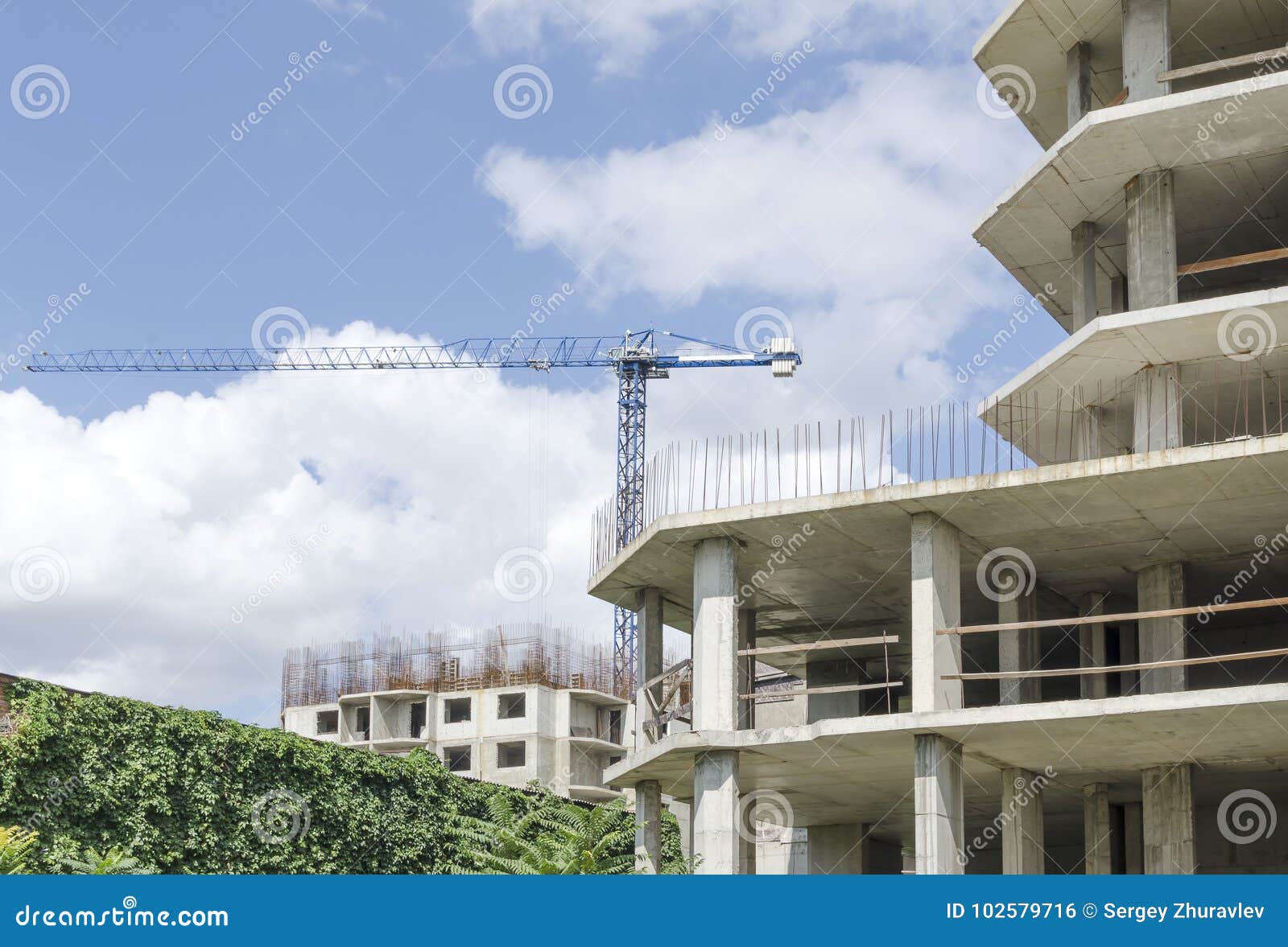 Two Buildings Under Construction on a Background of Clouds. Stock Photo ...