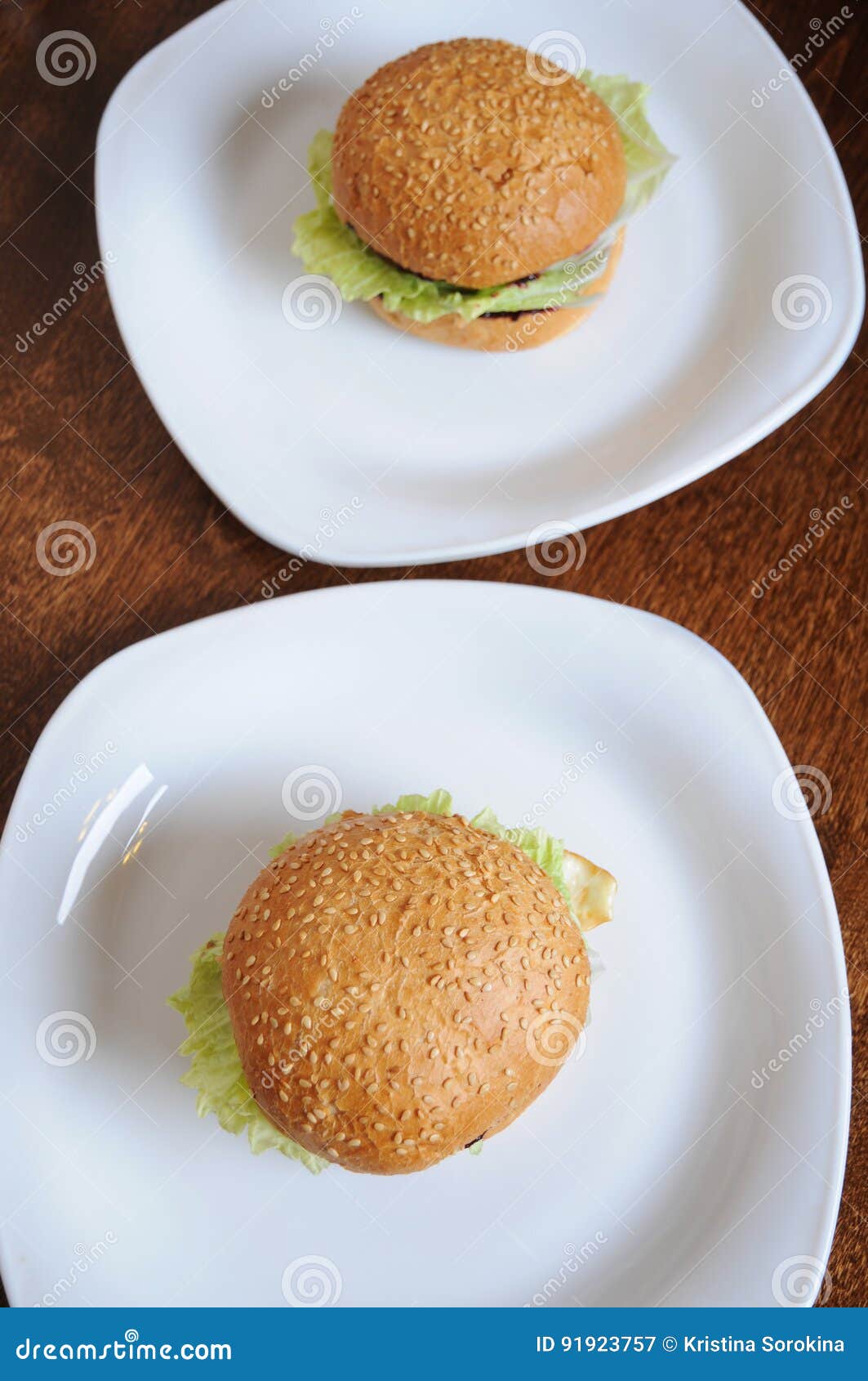 Two Burgers with Greens on a White Plates Top View Stock Image - Image ...