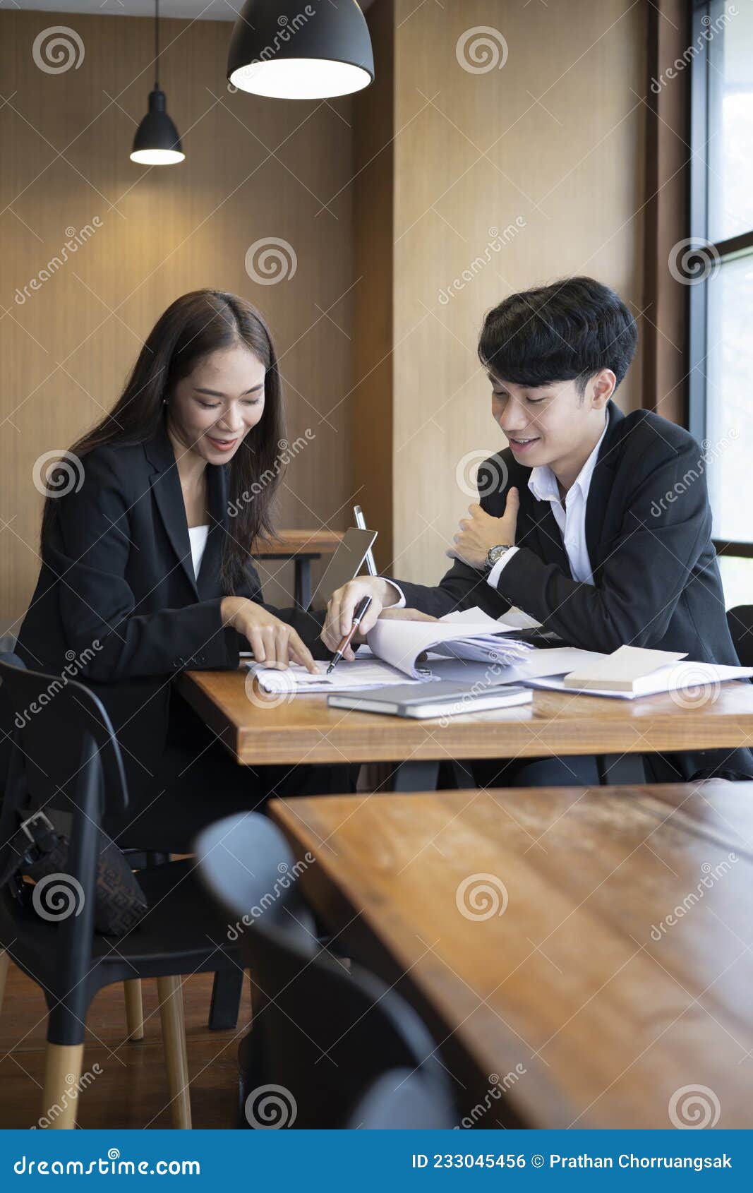 Two Business Colleagues Sitting in Office and Reading Paperwork ... Two Business Colleagues Sitting in Office and Reading Paperwork ...