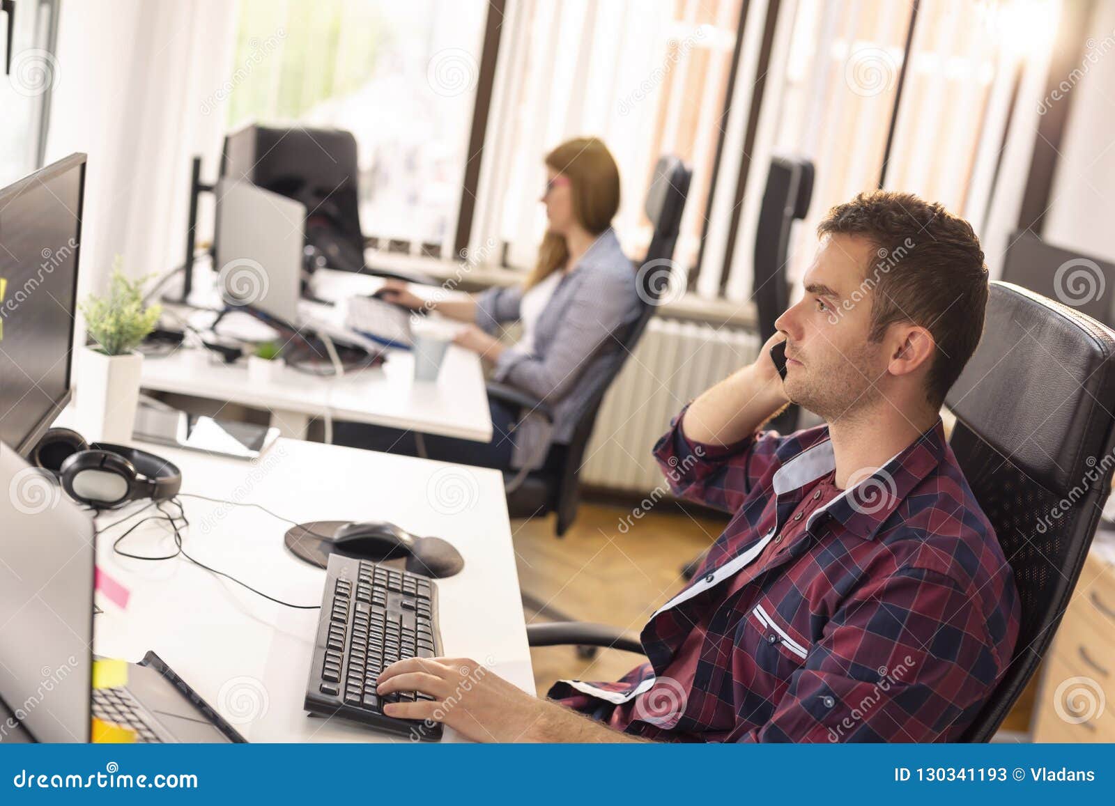 Making a Phone Call at Work Stock Image - Image of develop, laptop ...