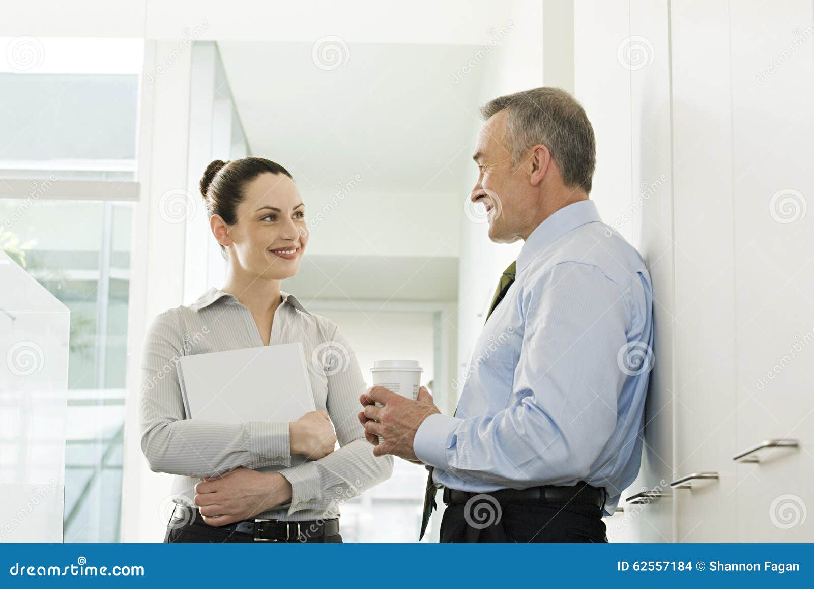 Two Business Colleagues Talking in Corridor Stock Photo - Image of head ...