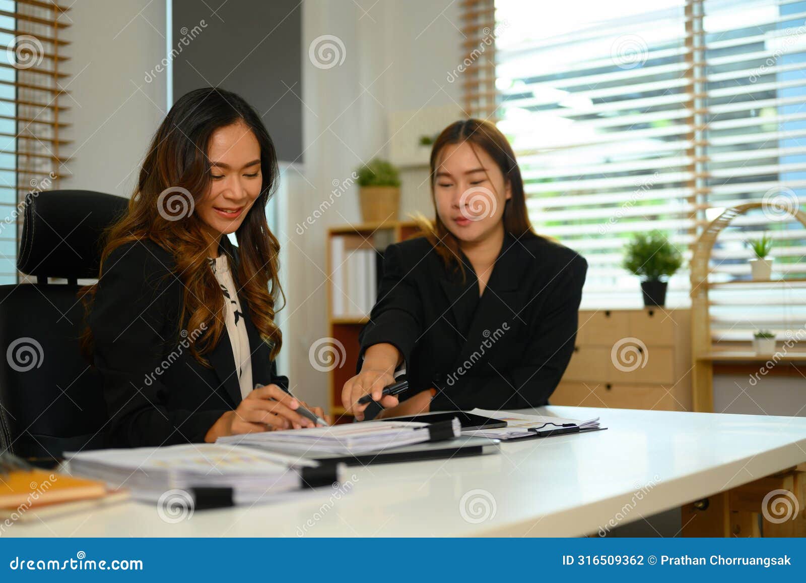Two Business Colleagues Working Together on Marketing Projects at ...