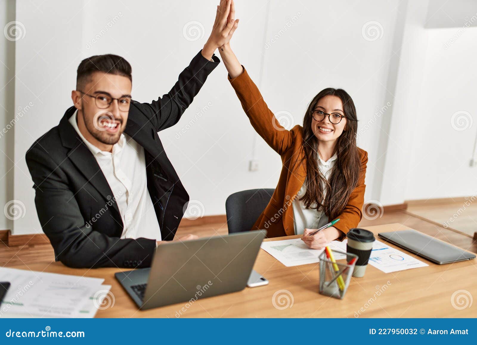Two Business Executives Raised Up Hands Hitting Five at the Office ...