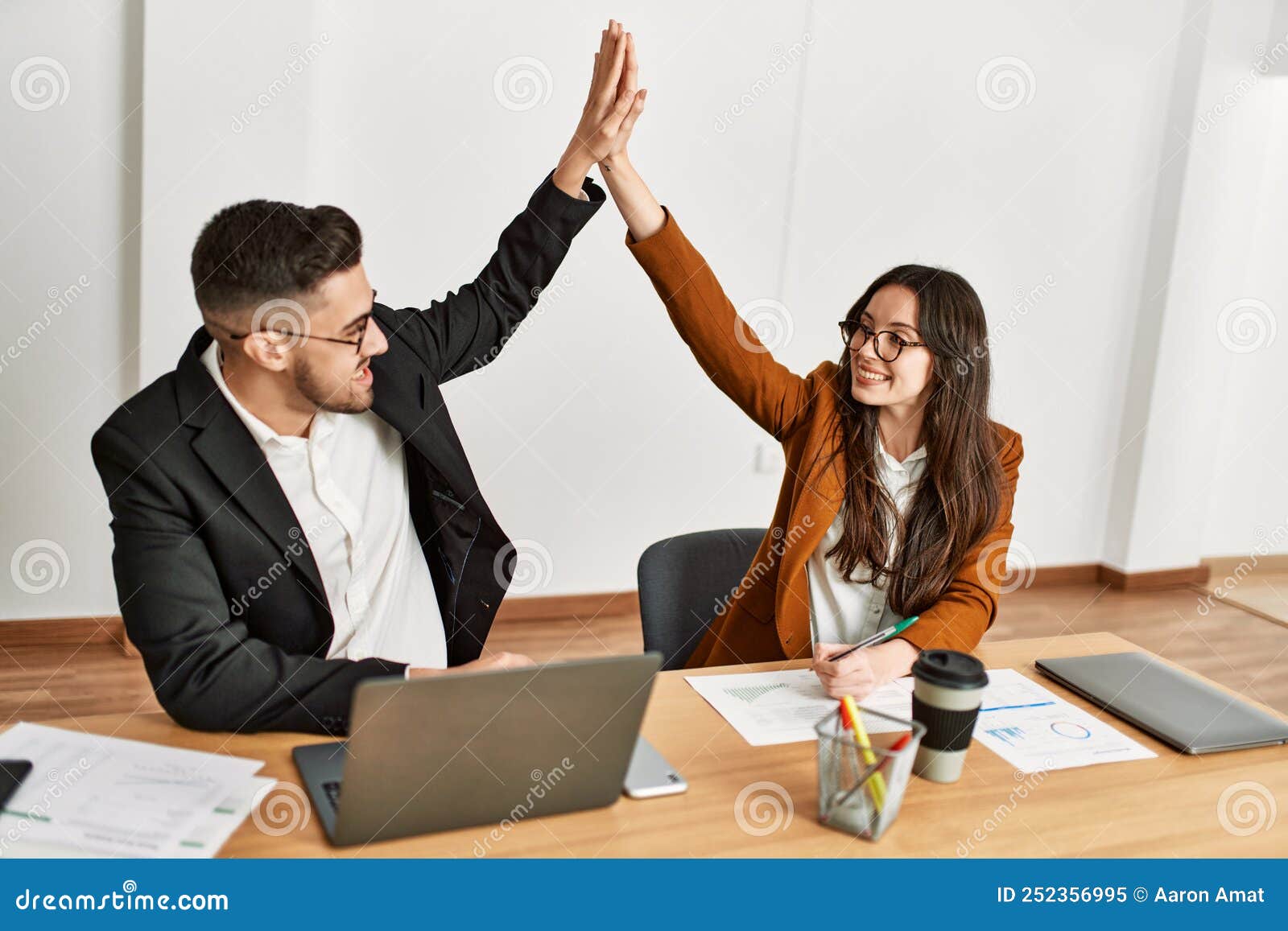 Two Business Executives Raised Up Hands Hitting Five at the Office ...