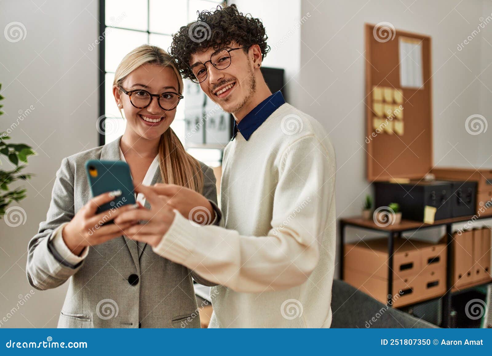 Two Business Executives Smiling Happy Using Smartphone at the Office ...