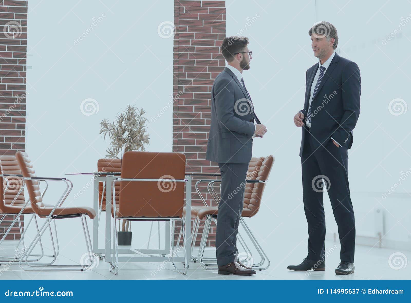 Two Business Executives Talking about Business in the Office. Stock ...