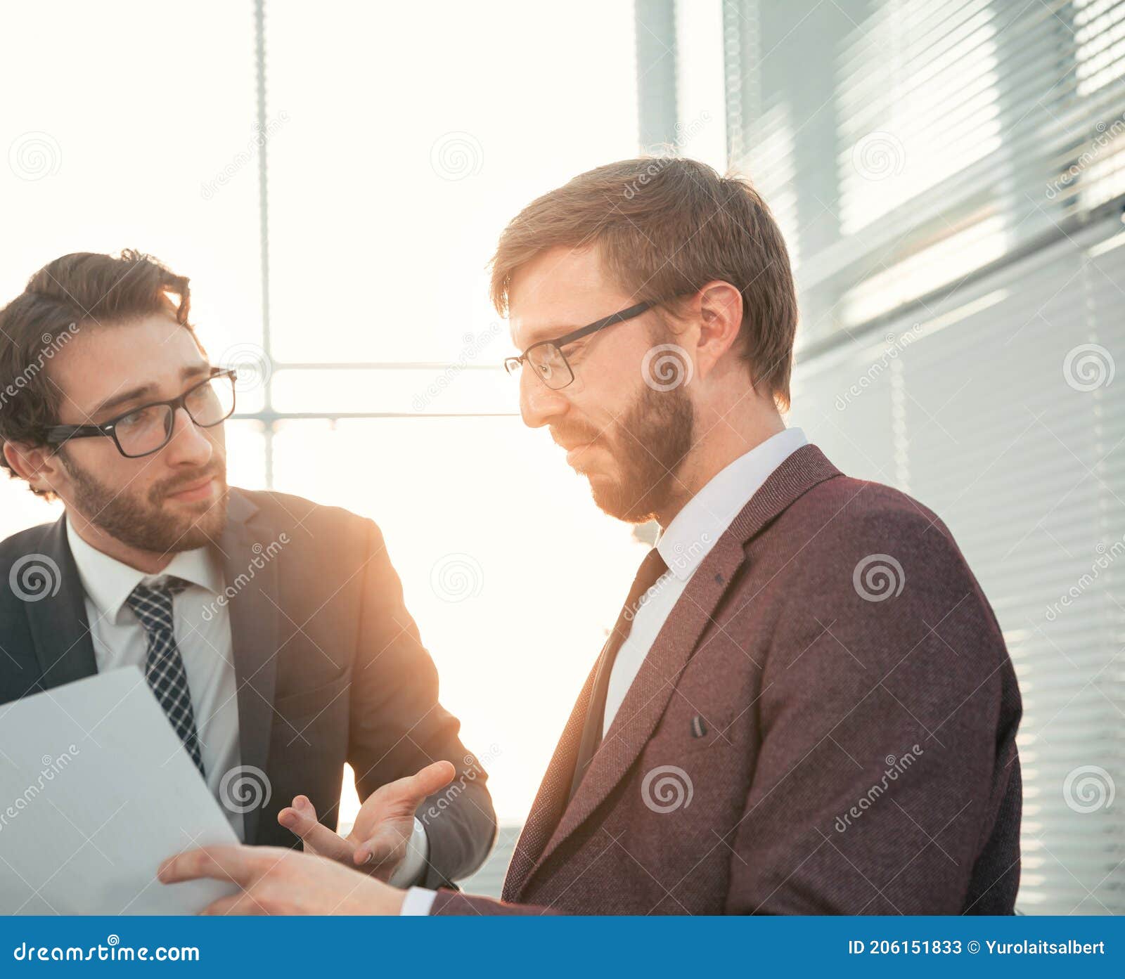 Two Business Men Discussing a Business Document. Stock Image - Image of ...