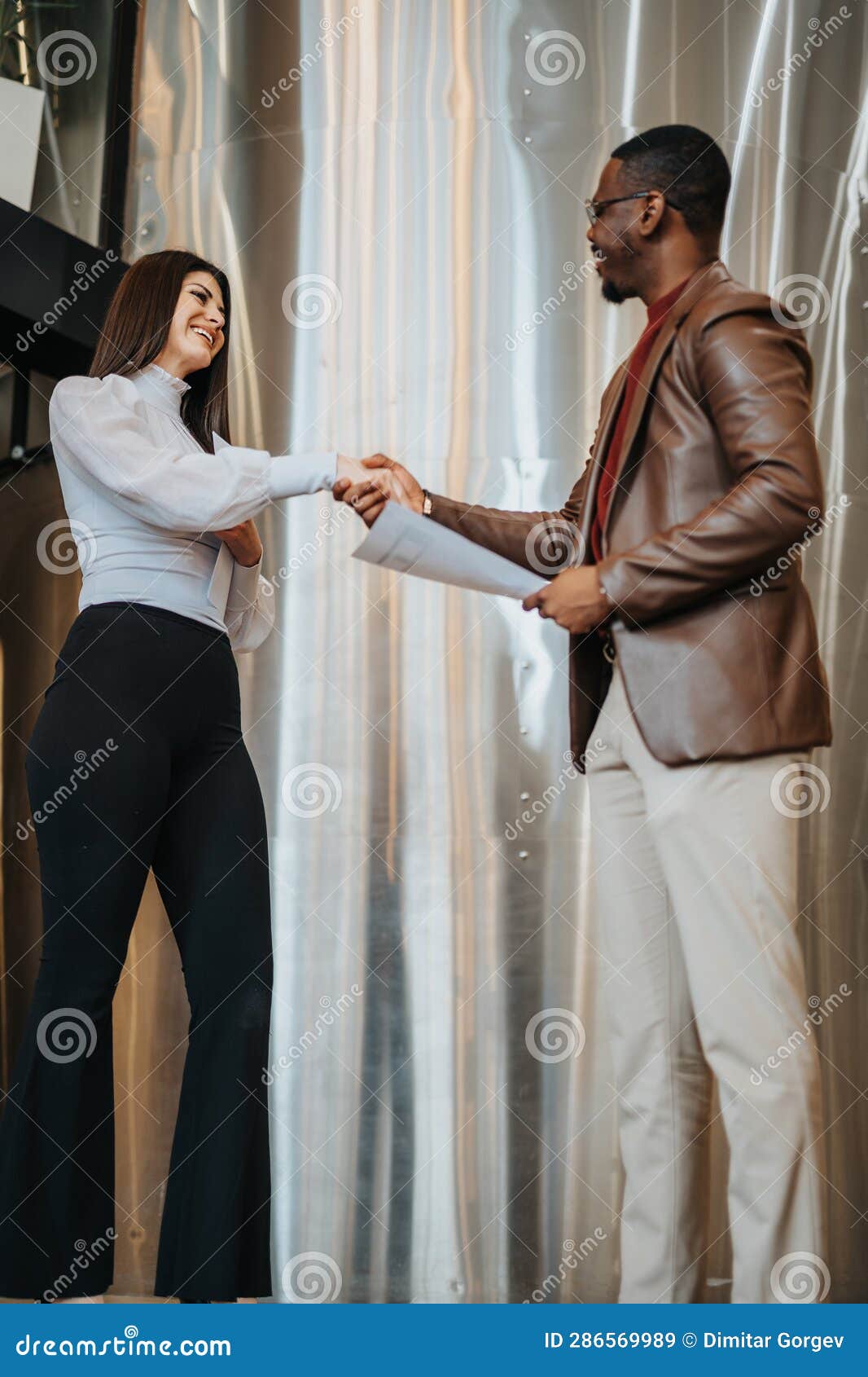 Two Business Partners Conducting Business, Such As Signing Contracts ...