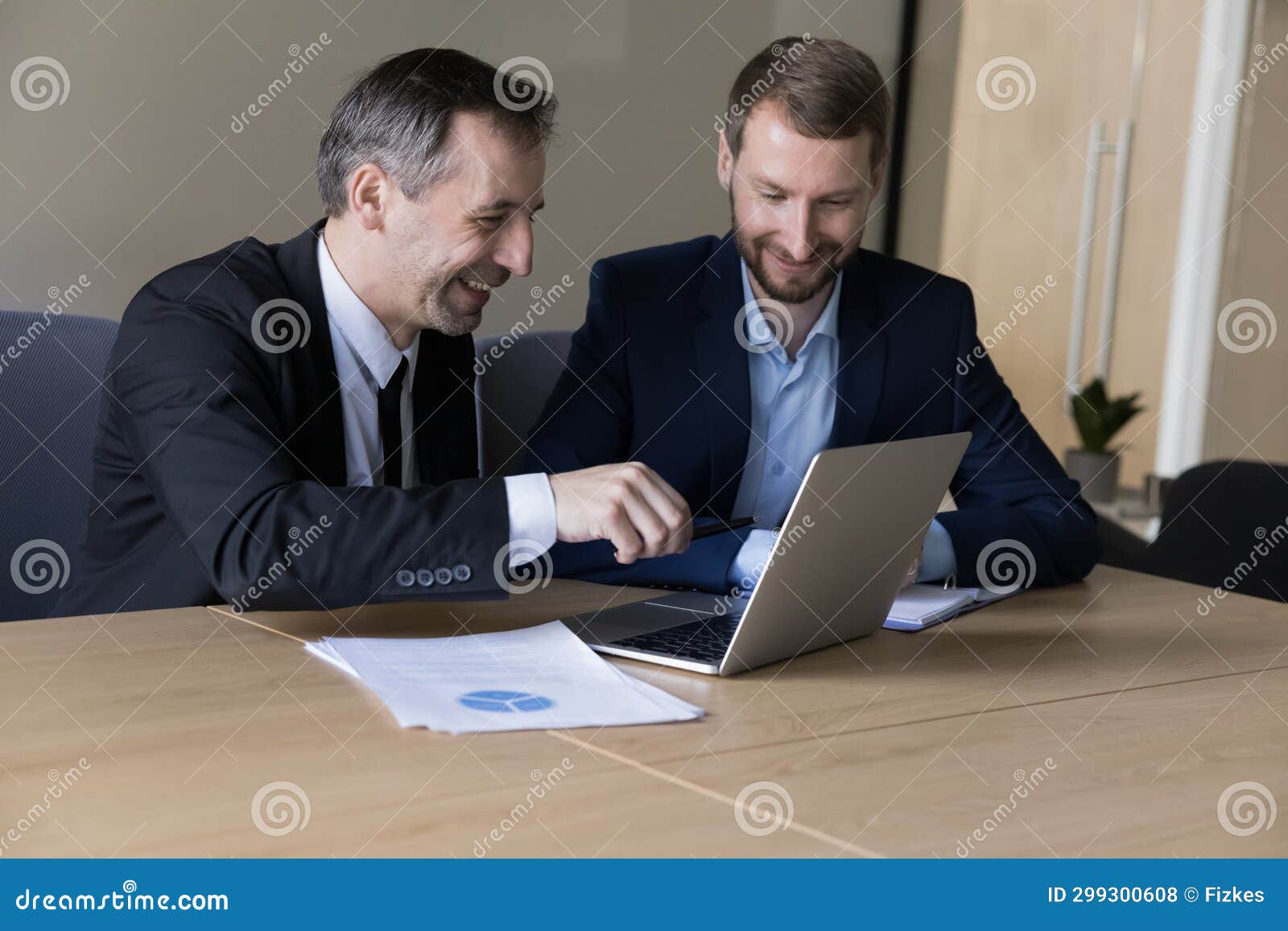 Two Business Partners Discuss on-line Project Using Laptop Stock Photo ...