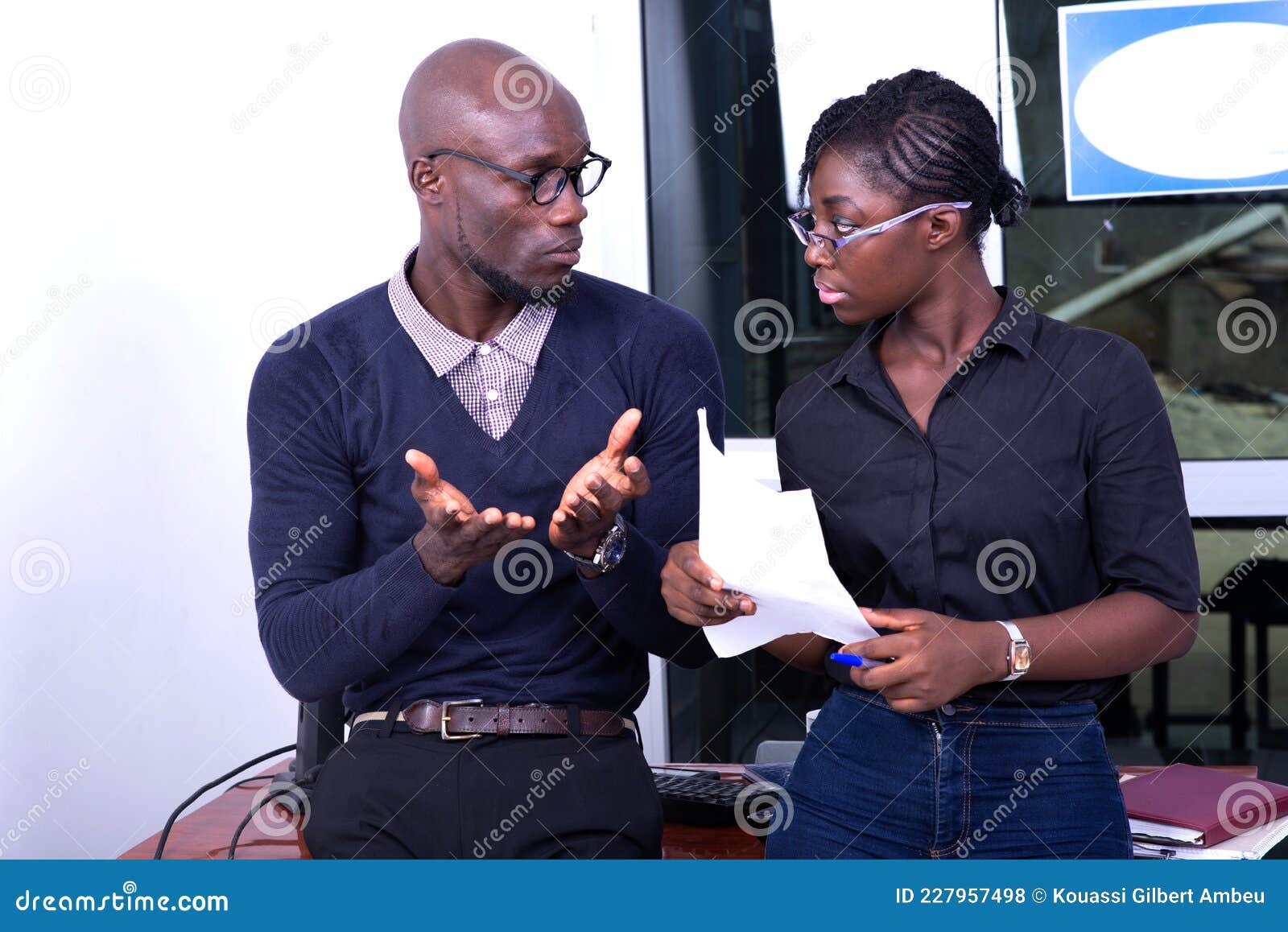 Two Business Partners Discussing Report Notes on Document in Office ...