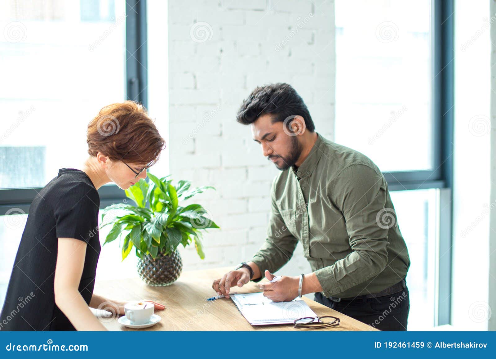 Two Business People Discuss Meeting Table with Documents and Write ...
