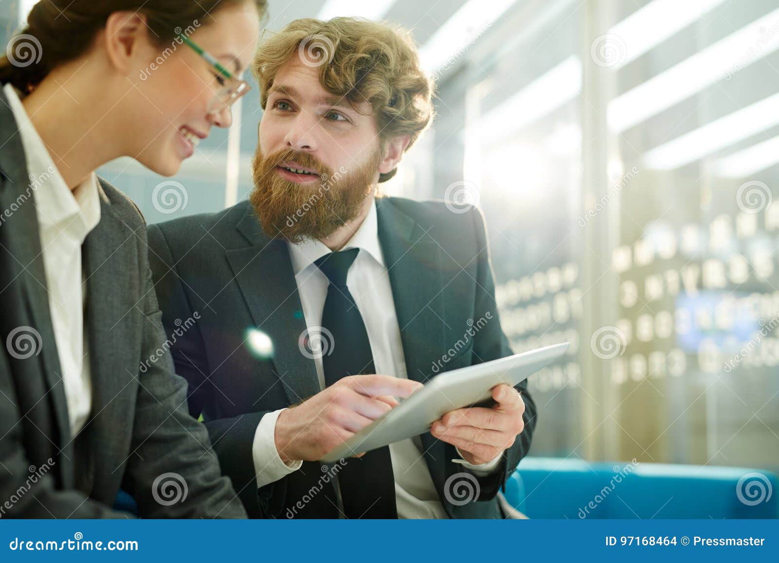 Two Business People Discussing Work in Office Stock Photo - Image of ...