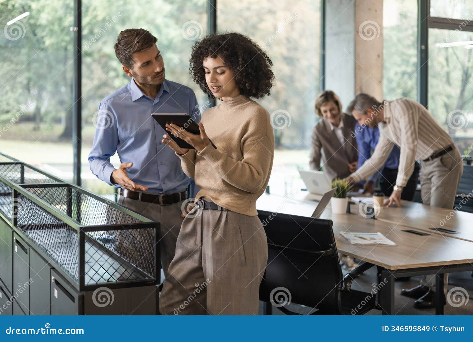 Two Business People Discussing Work Together Using a Tablet in a Modern ...