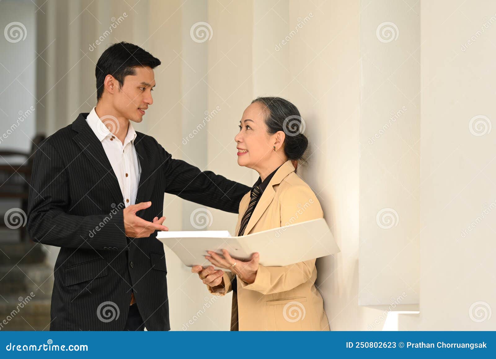 Two Business People Having a Discussion and Standing Under the Office ...