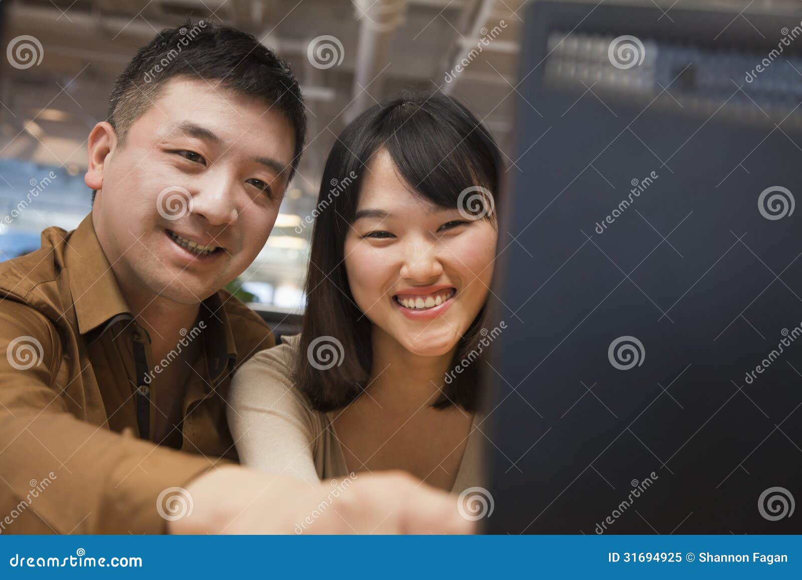 Two Business People Looking at Computer in the Office Stock Image ...