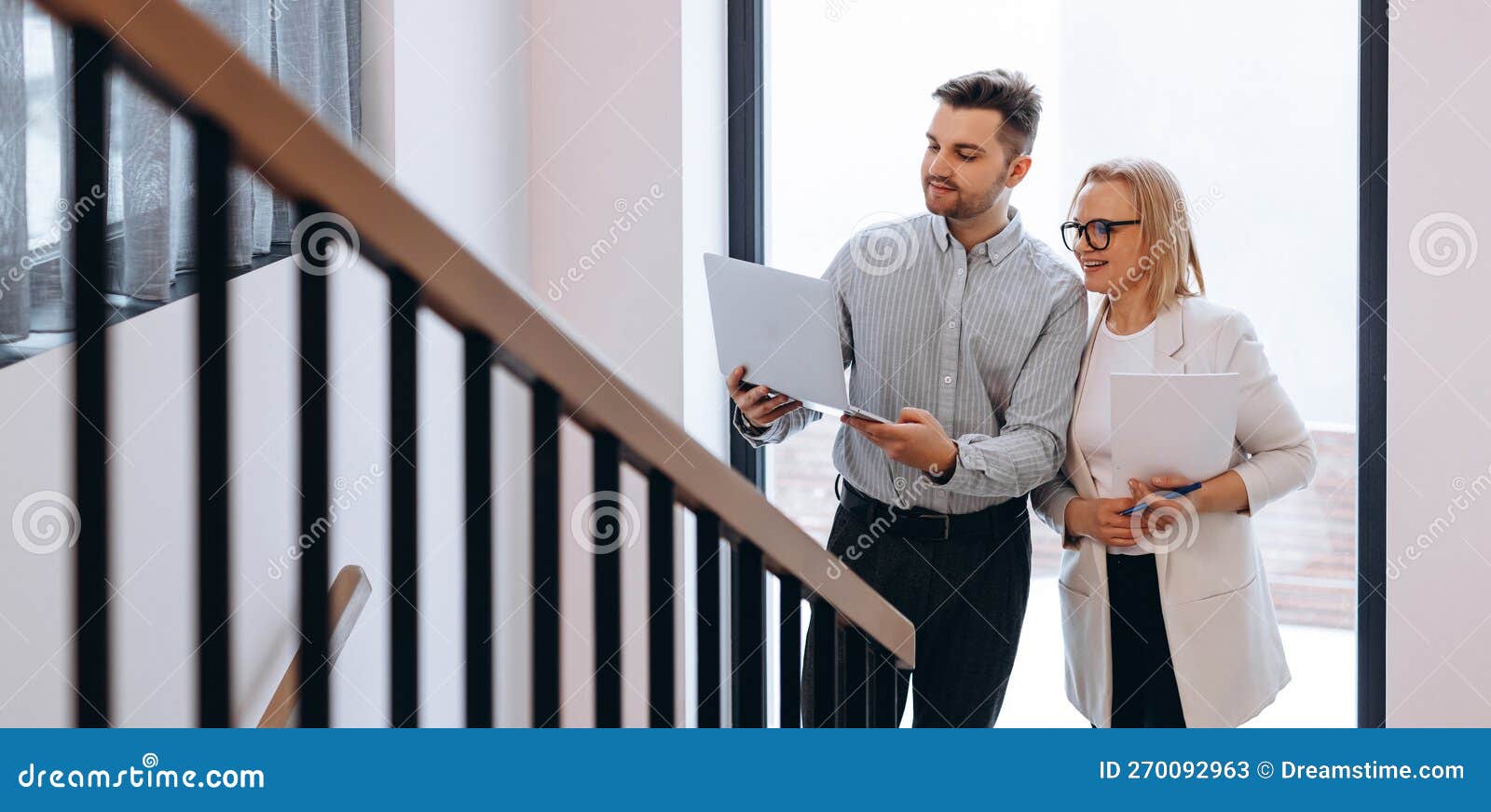Two Business People Looking at Laptop and Smiling Stock Image - Image ...