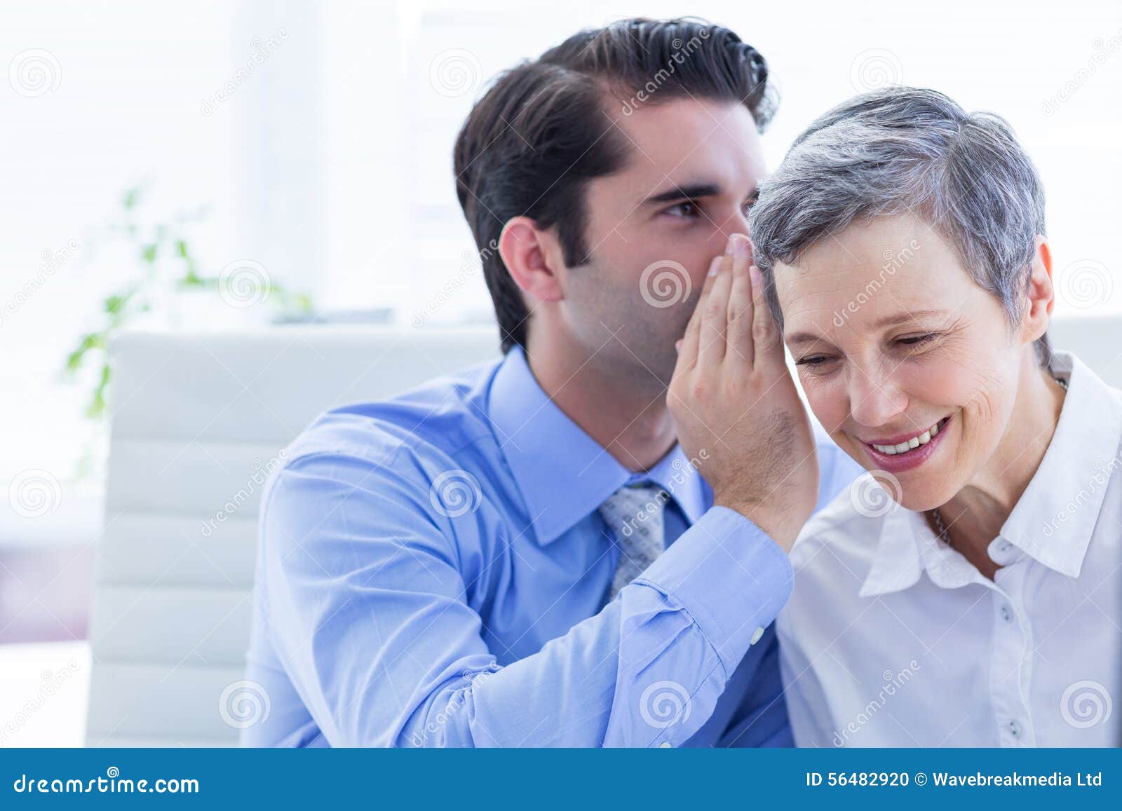 Two Business People Looking at a Paper while Working on Folder Stock ...