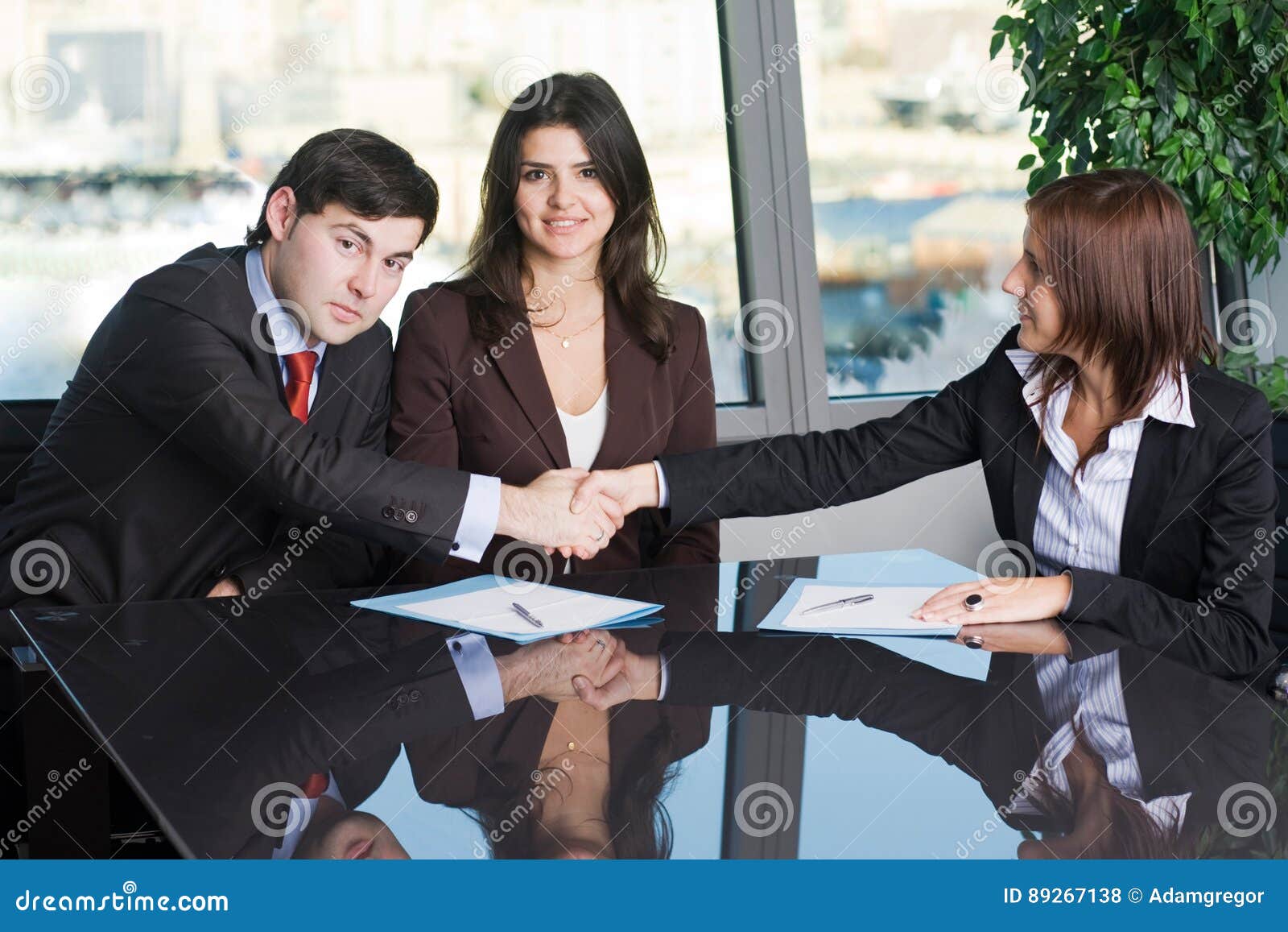 Two Business People Making a Handshake Over a Deal Stock Photo - Image ...