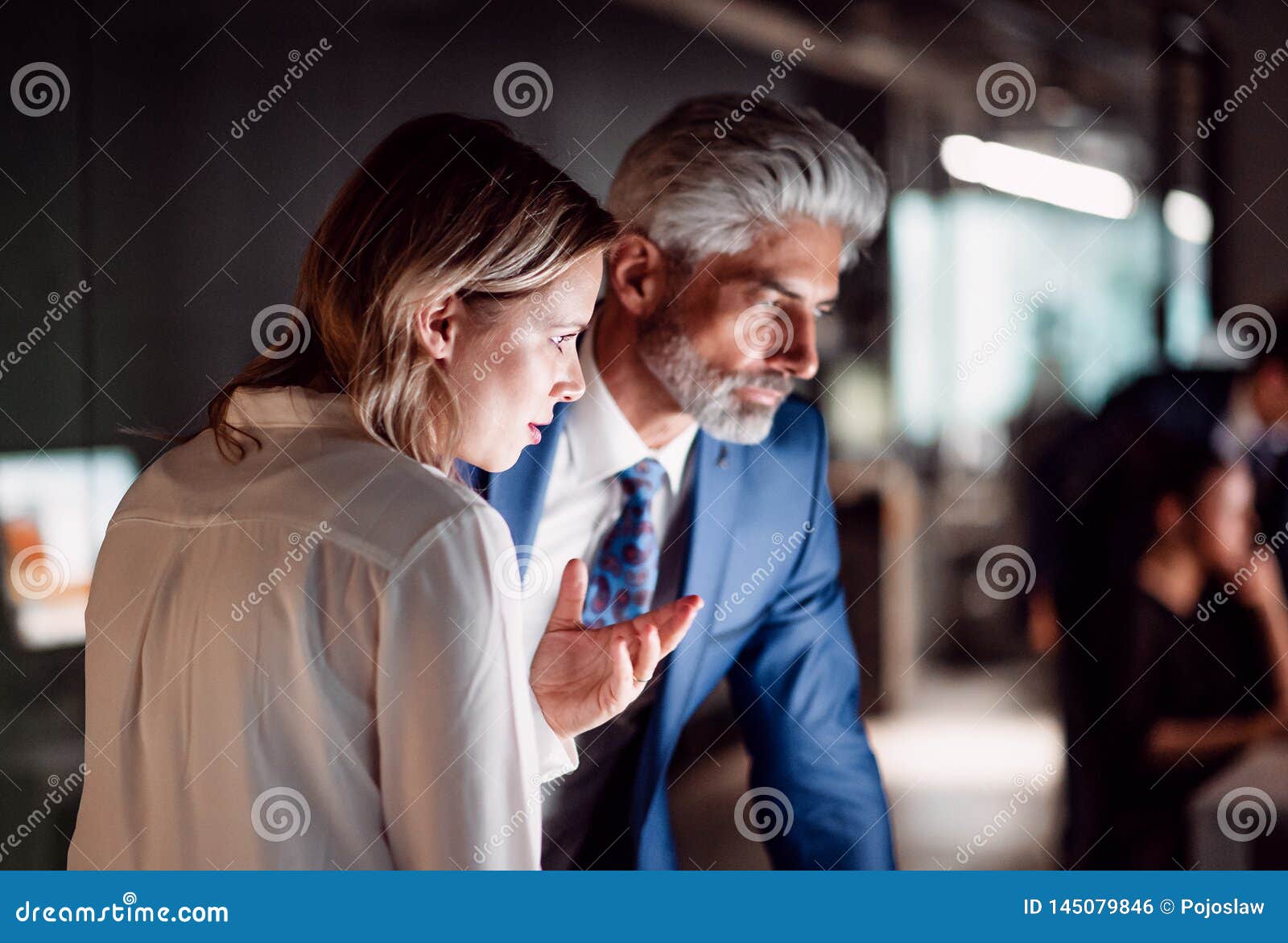 Two Business People in an Office at Night., Working. Stock Photo ...