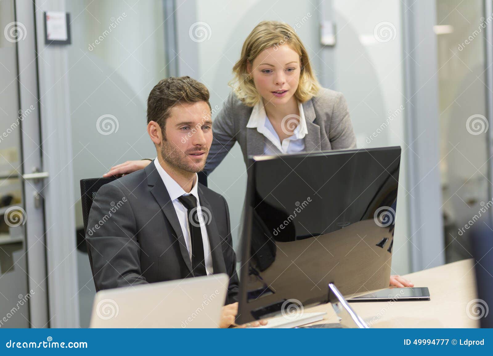 Two Business People in a Office, Working on Computer Stock Image ...