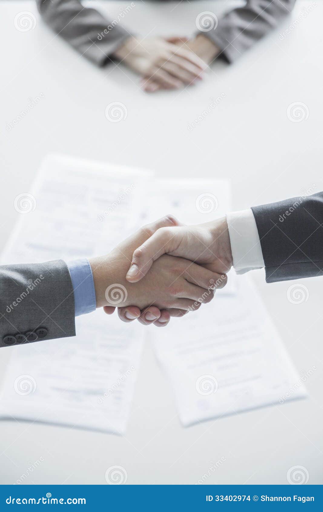 Two Business People Shaking Hands Over the Table, Hands only Stock ...