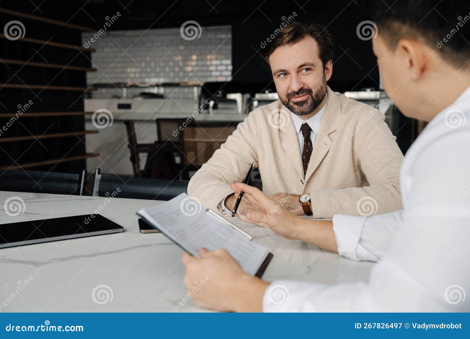 Two Business People Sitting by Office Table and Discussing Project ...