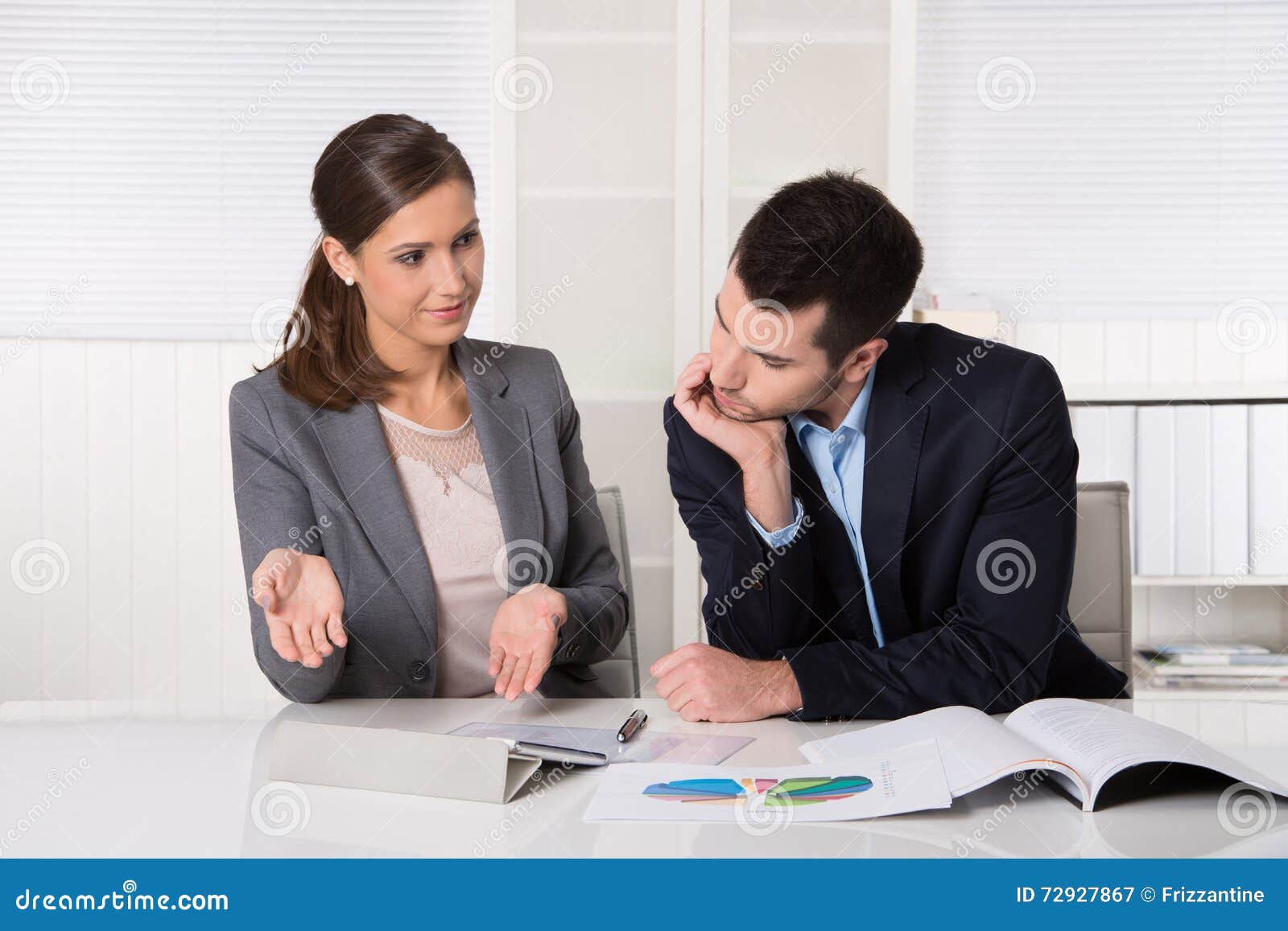 Two Business People Sitting in the Office Talking and Analyzing Stock ...