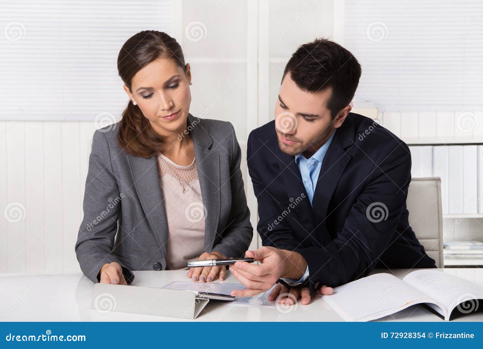 Two Business People Sitting in the Office Talking and Analyzing Stock ...