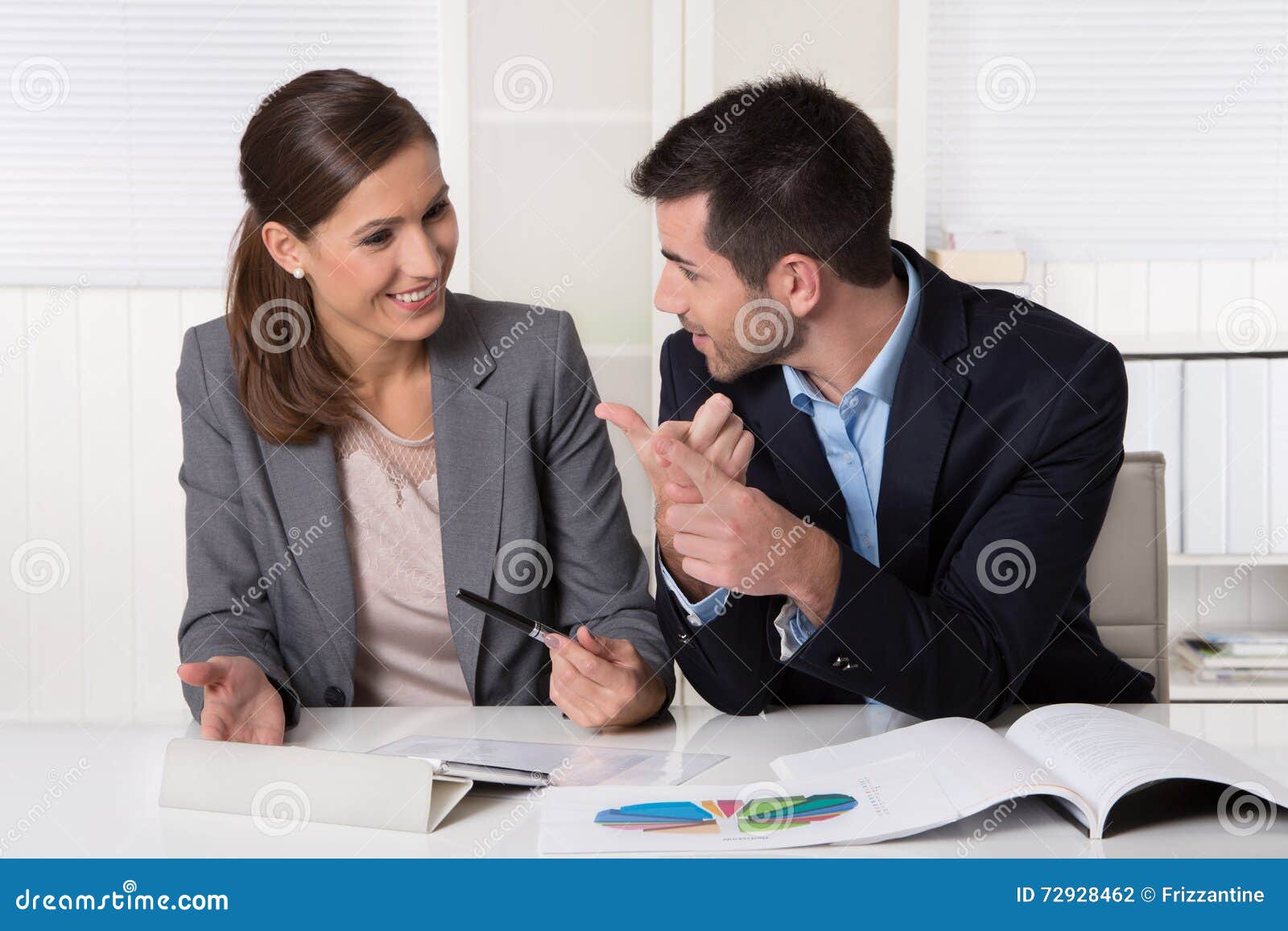 Two Business People Sitting in the Office Talking and Analyzing Stock ...