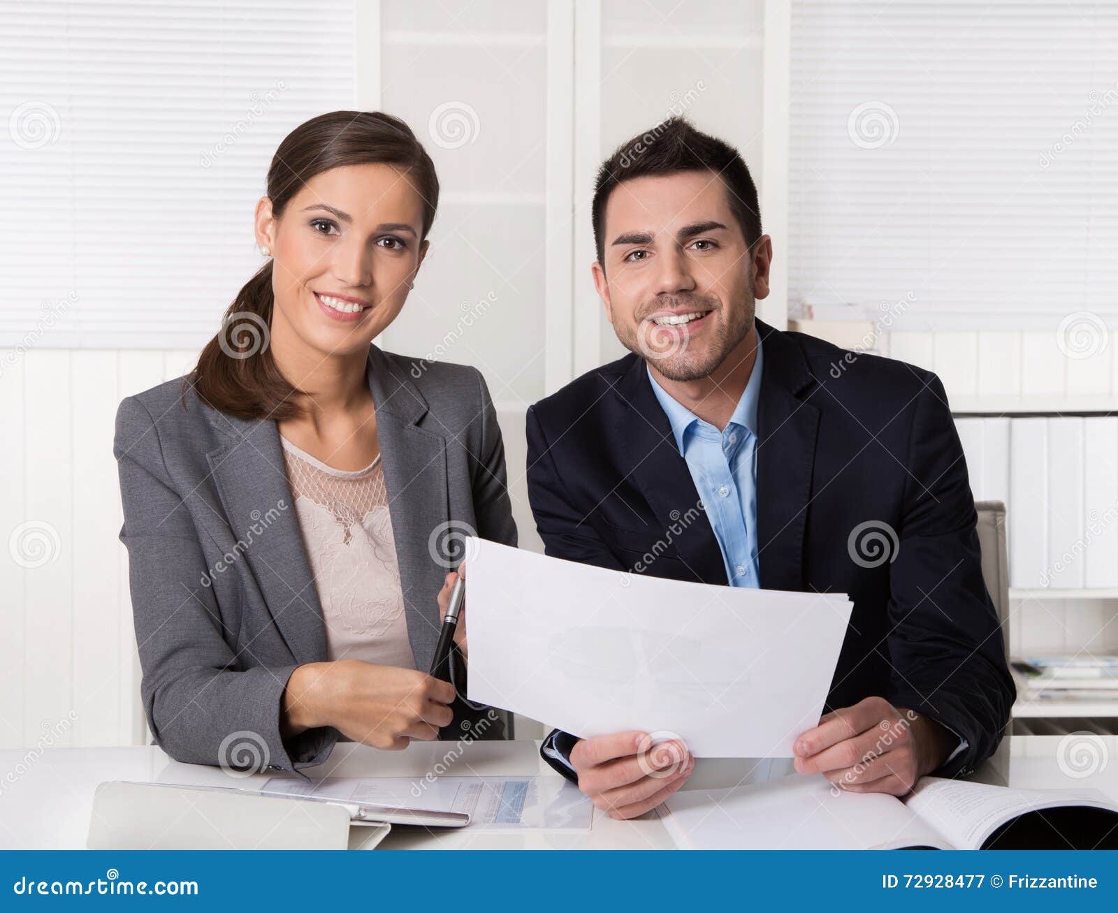 Two Business People Sitting in the Office Talking and Analyzing Stock ...