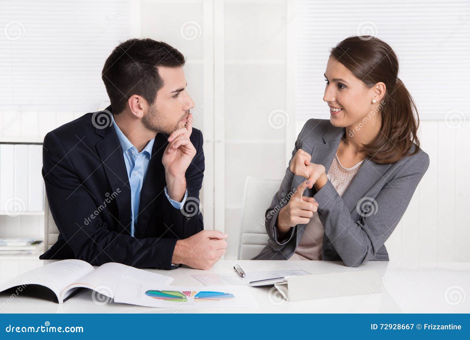 Two Business People Sitting in the Office Talking and Analyzing Stock ...