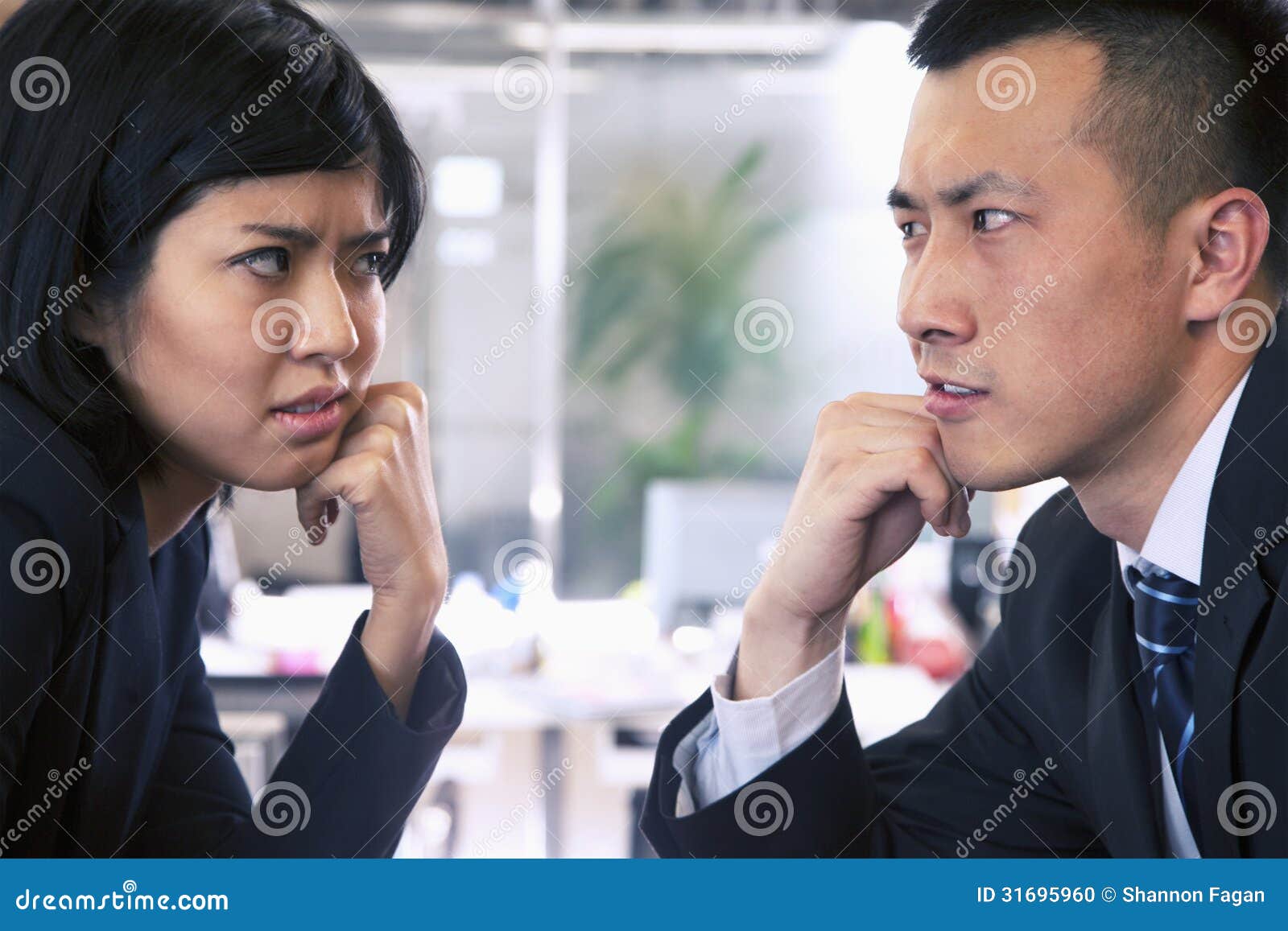 Two Business People Staring At Each Other Across A Table Stock Photo ...